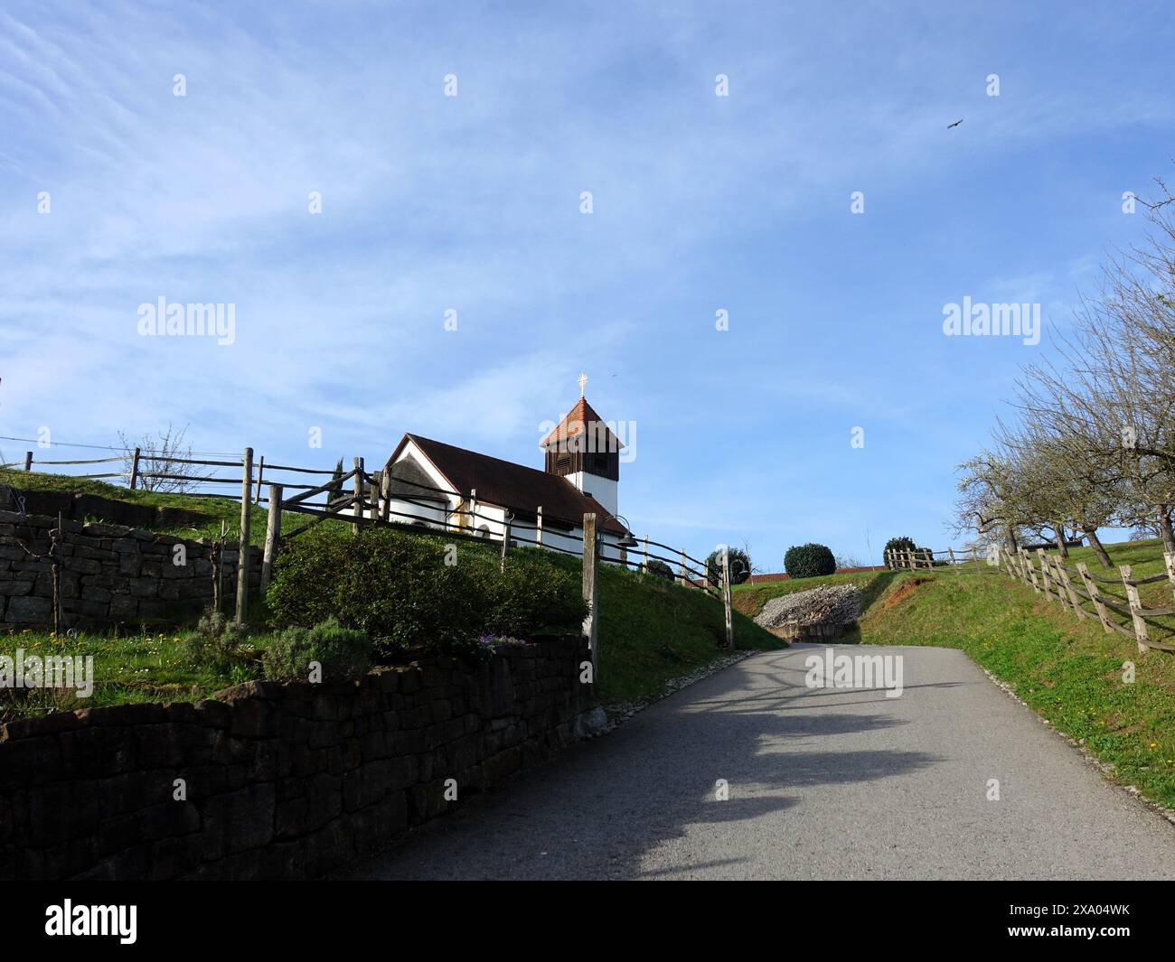 Stone path ascends to church with adjacent fenced area Stock Photo - Alamy