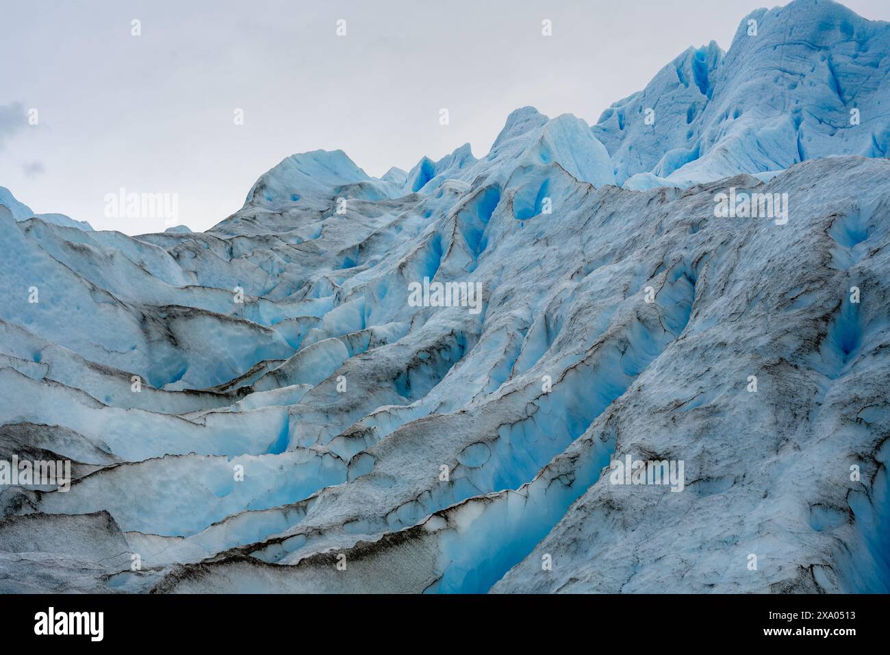 Flowing blue ice cascades down a glacier's side Stock Photo - Alamy