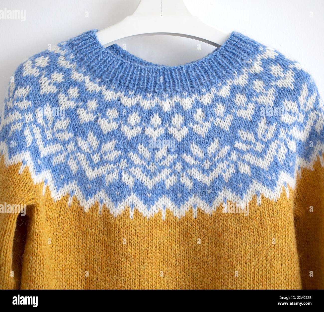 Close-up photo of a large blue, white, yellow yoke of a knitted wool ...
