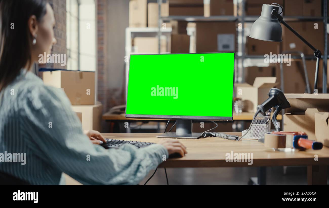Female Using Desktop Computer with a Green Screen Chromakey Mock Up Display. Sales Manager and ...