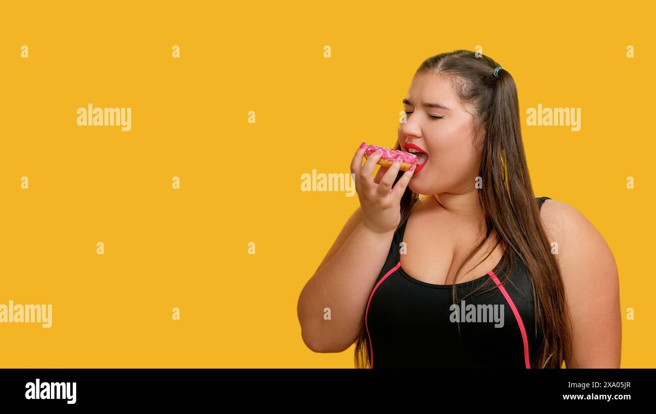 Enjoying food. Sweet donut. Hungry chubby overweight woman eating ...