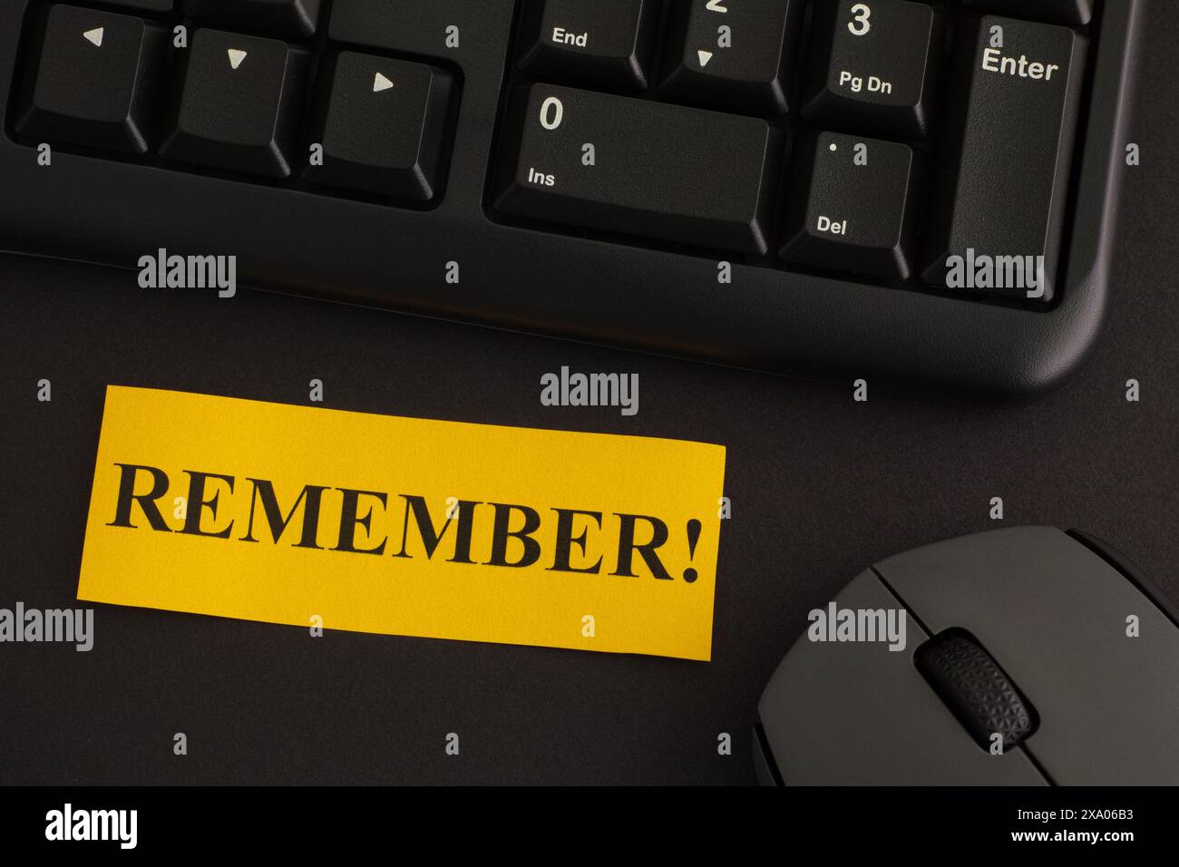 Remember! Paper note with writing Remember on a desk with black ...