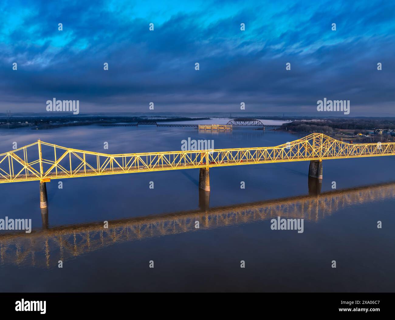 A train bridge over water with a boat passing underneath Stock Photo ...