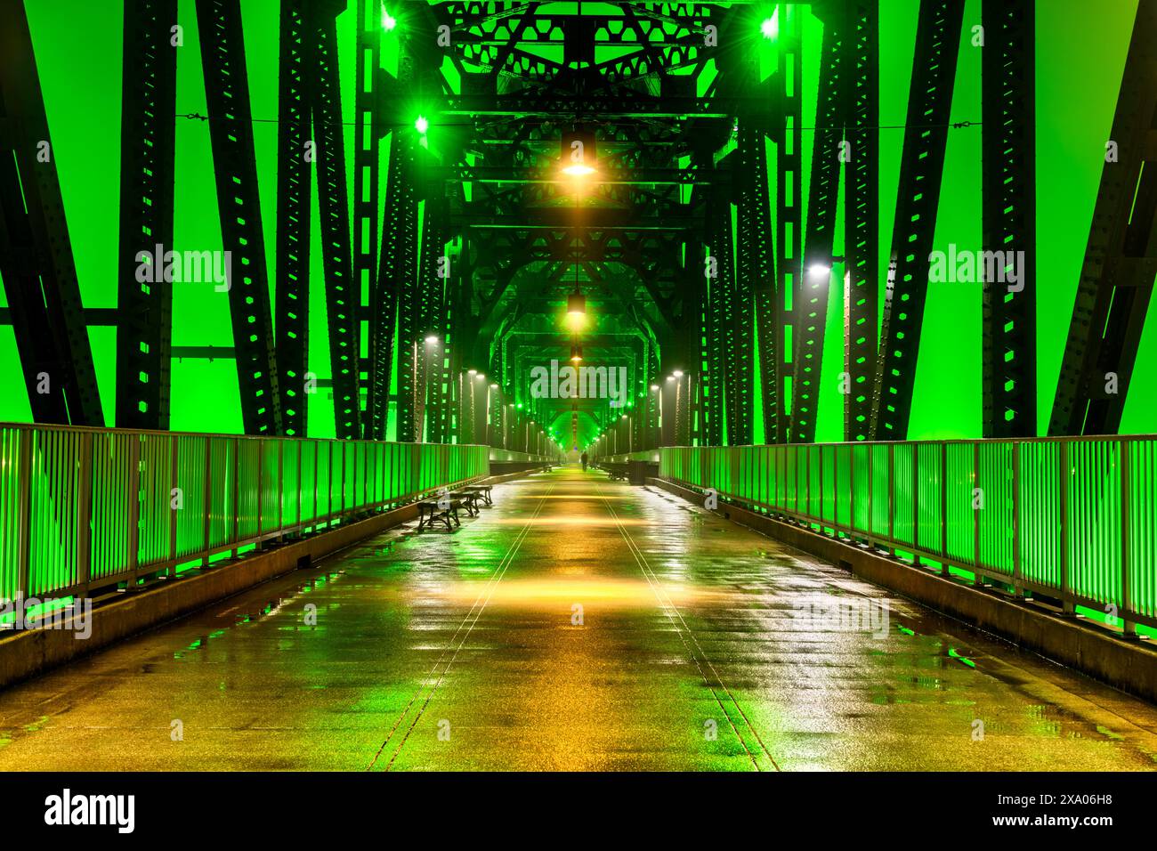 City lights reflected on a walkway lit with green lights Stock Photo ...