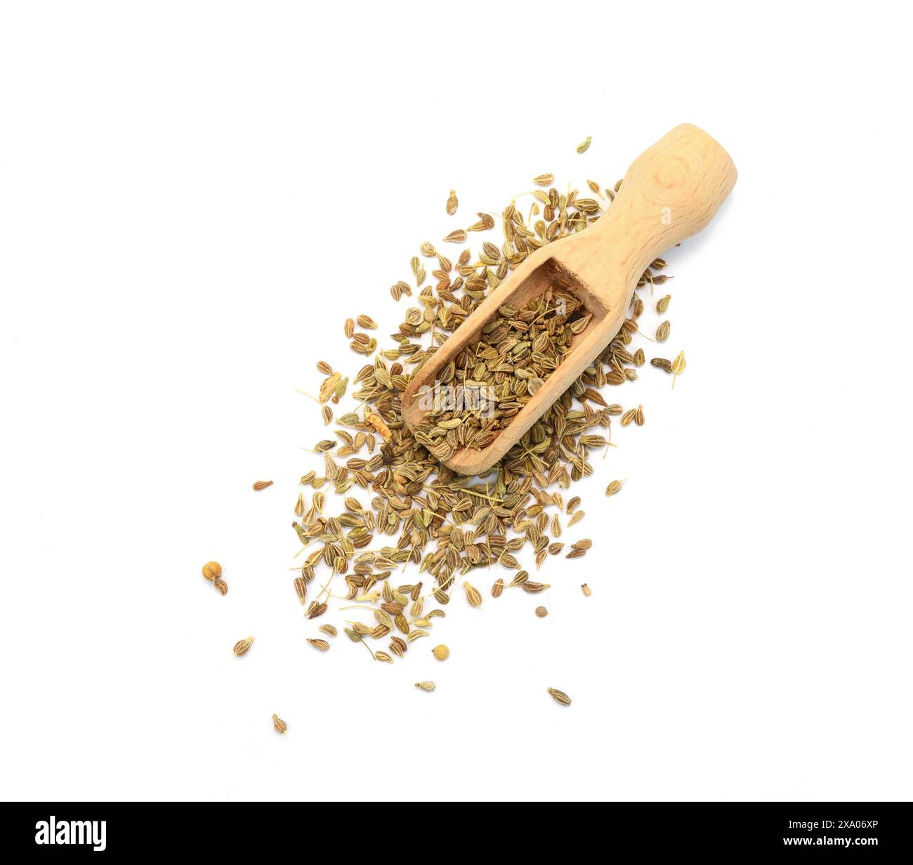 Dried anise seed (aniseed) in a wooden scoop isolated on white ...