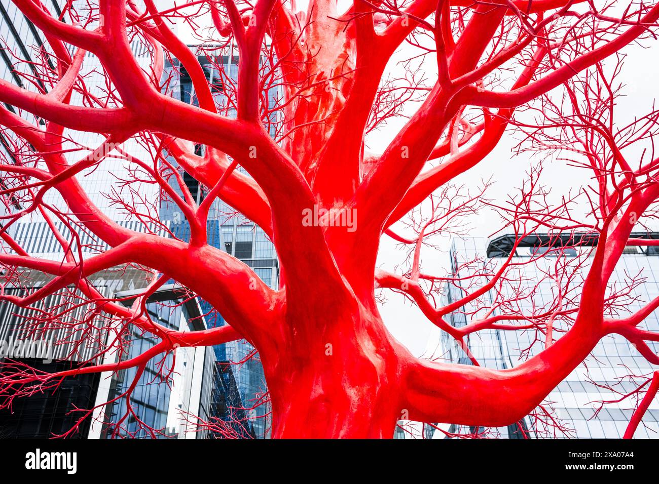 A red tree with modern buildings in the background. New York City Stock ...