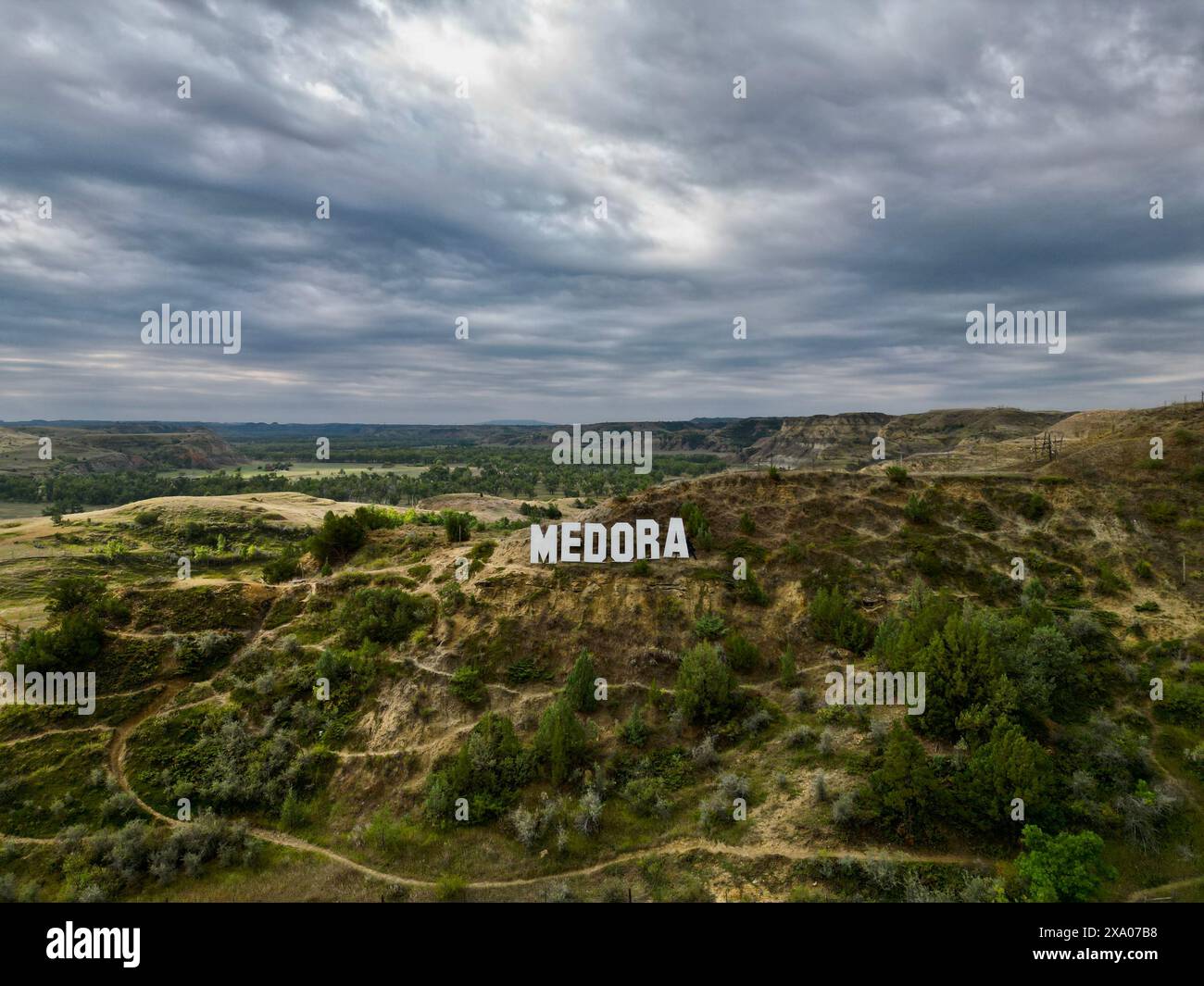 The Medora sign on a hill with a cloudy sky in Medora, North Dakota ...