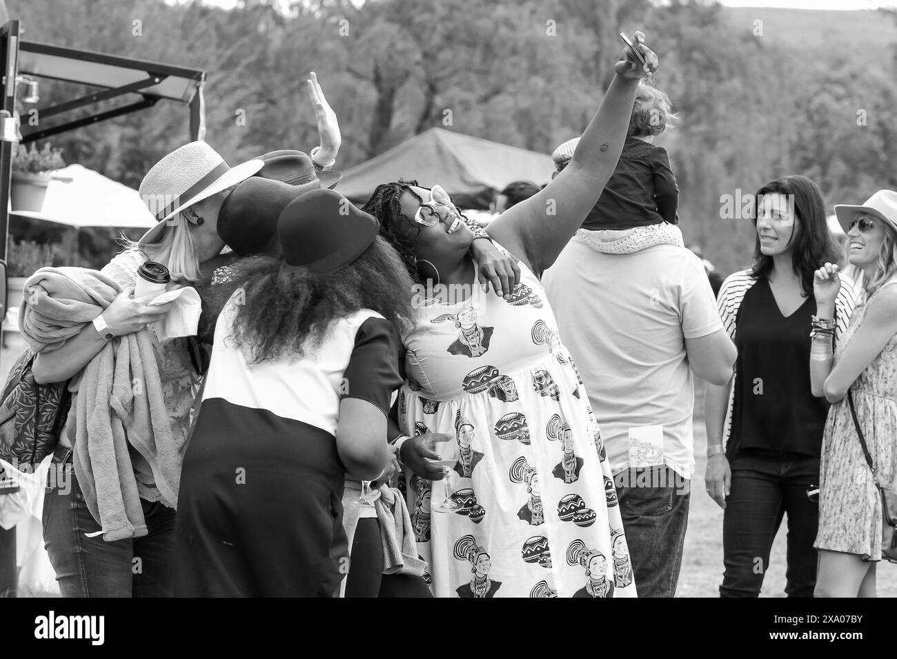 A group of people having a good time in the countryside in grayscale ...