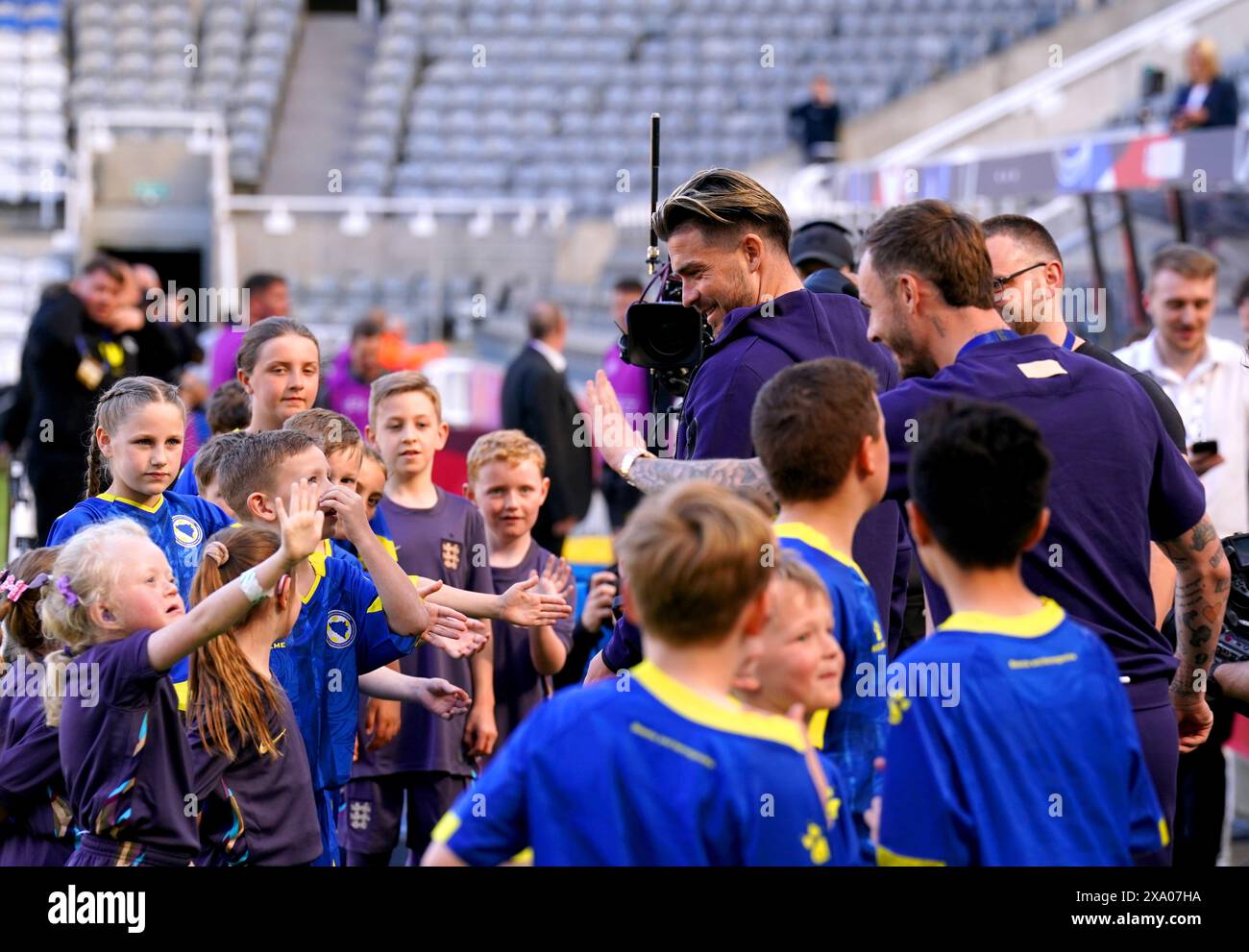 England's Jack Grealish and James Maddison speak to the mascots ahead ...