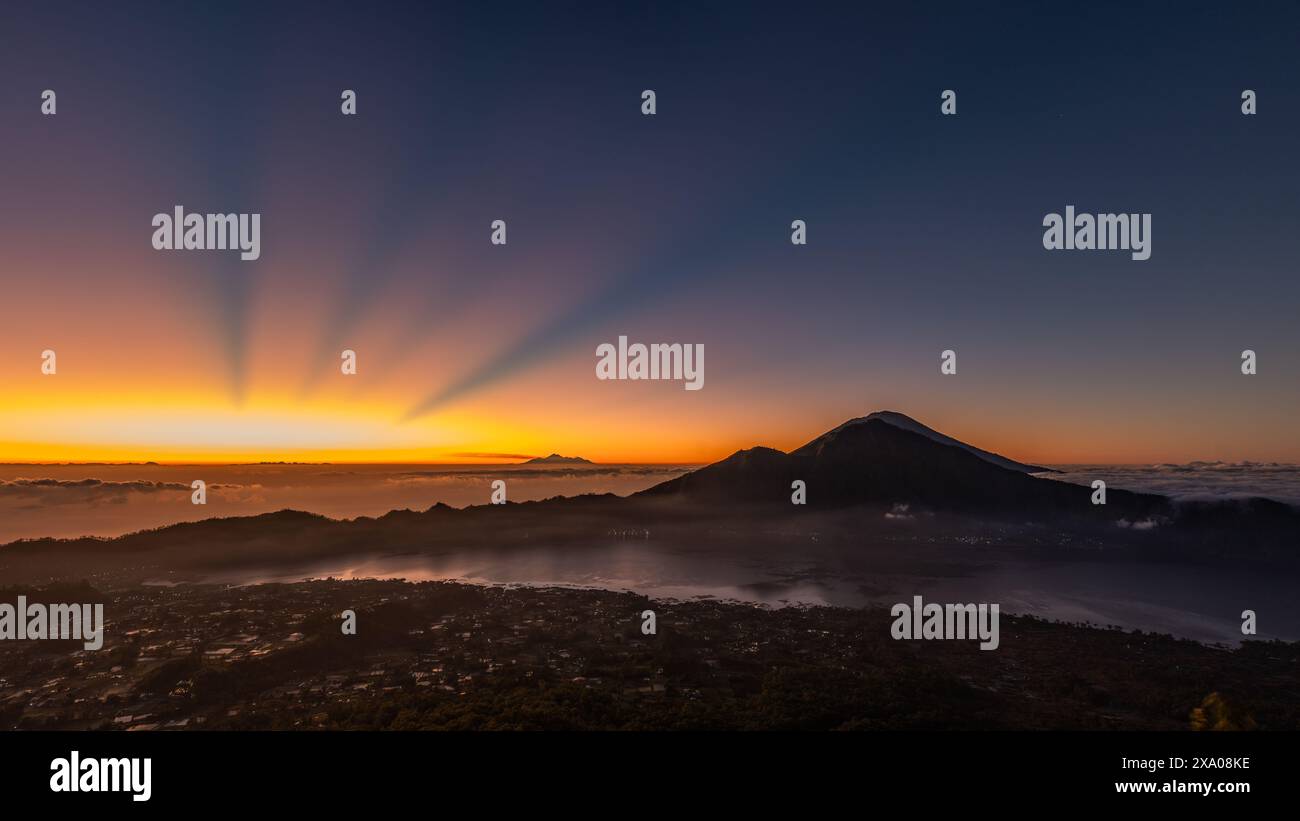 The sunrise with gentle light beams on the horizon at dawn Stock Photo ...