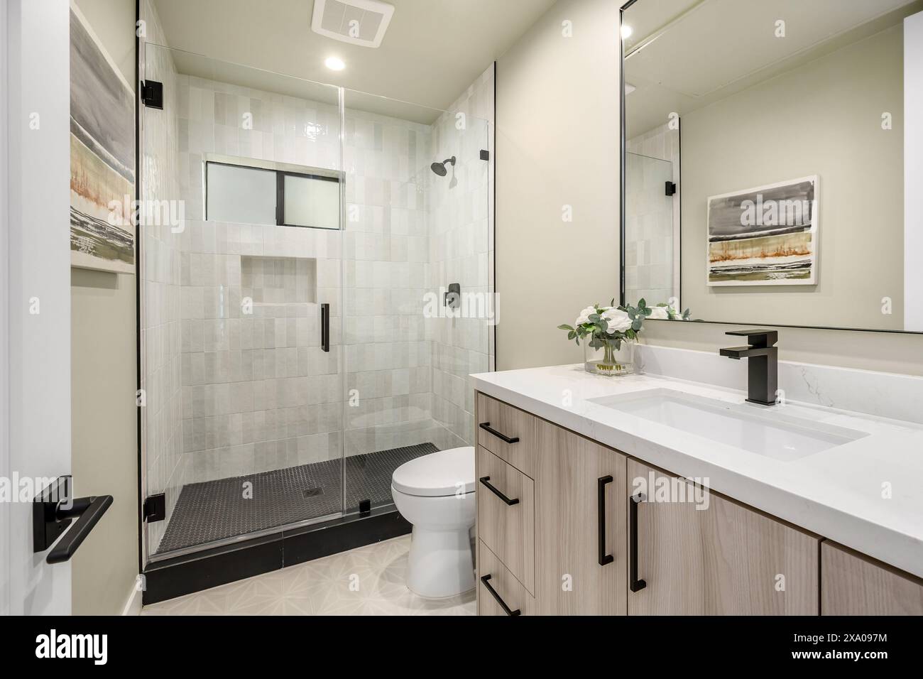 Modern bathroom with a shower, double sink counter, and toilet Stock ...