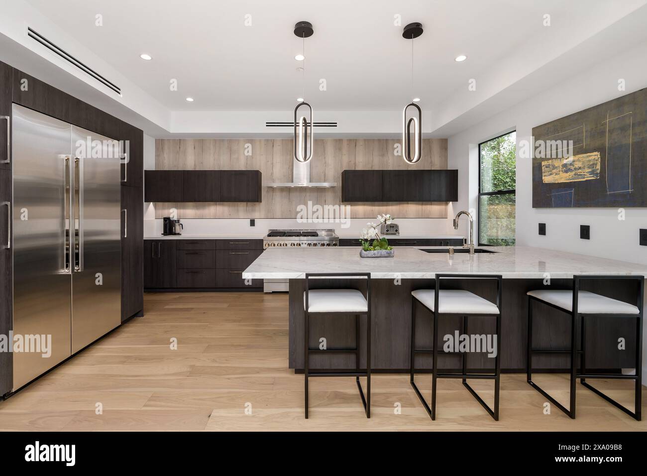 Spacious kitchen with wood panel walls and white countertops Stock ...