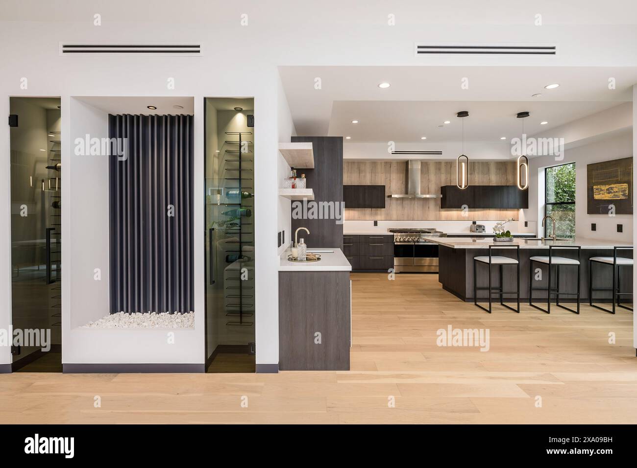A concept kitchen with white walls and wooden floors, connected to ...