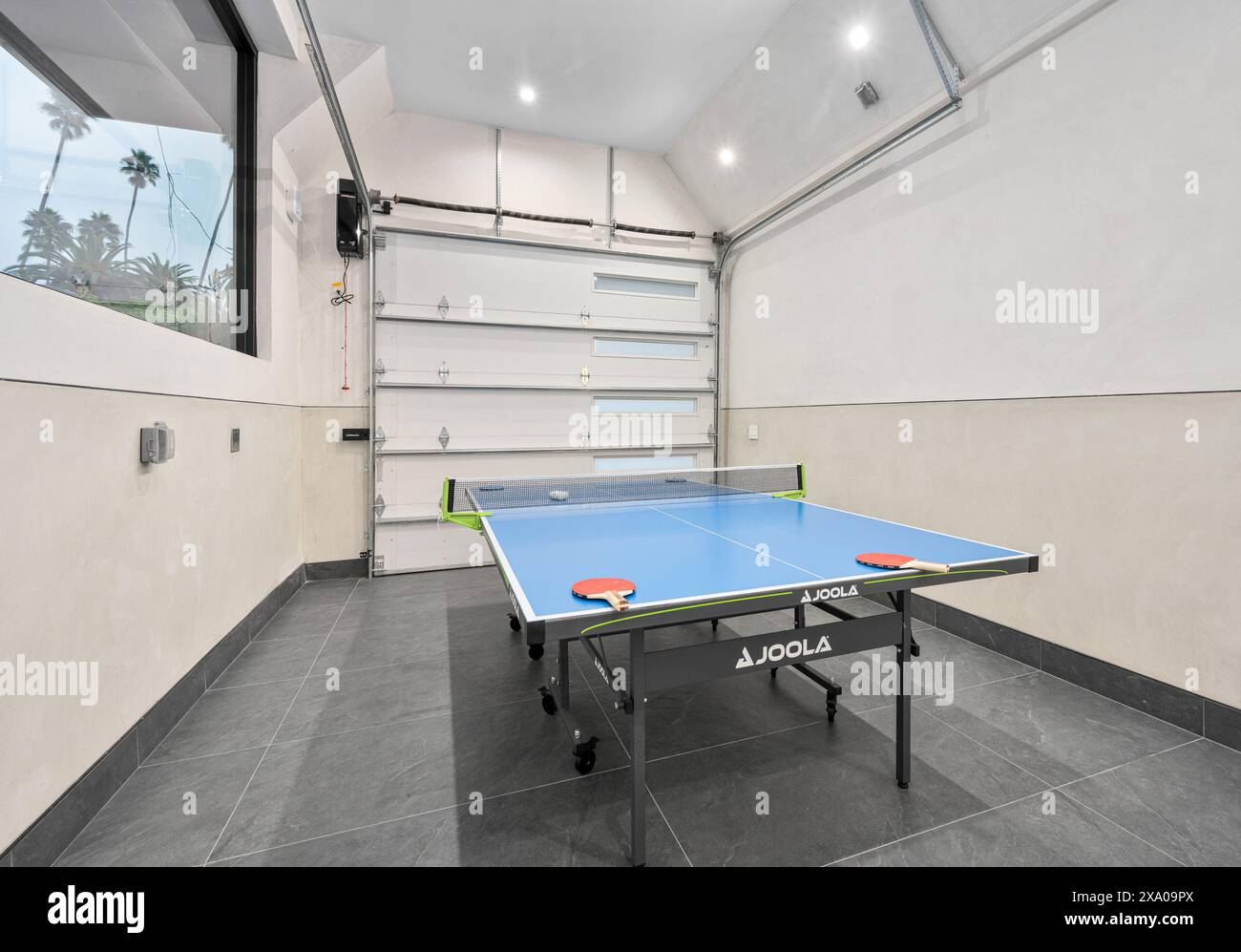 An indoor ping pong table in a recreational room Stock Photo - Alamy