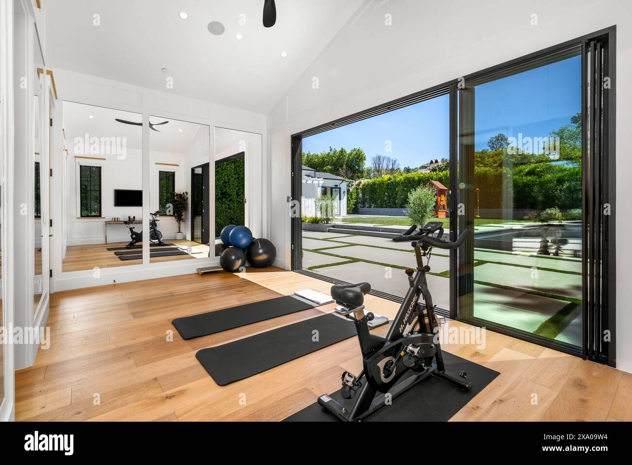 A fully equipped home gym with exercise equipment in the corner Stock ...