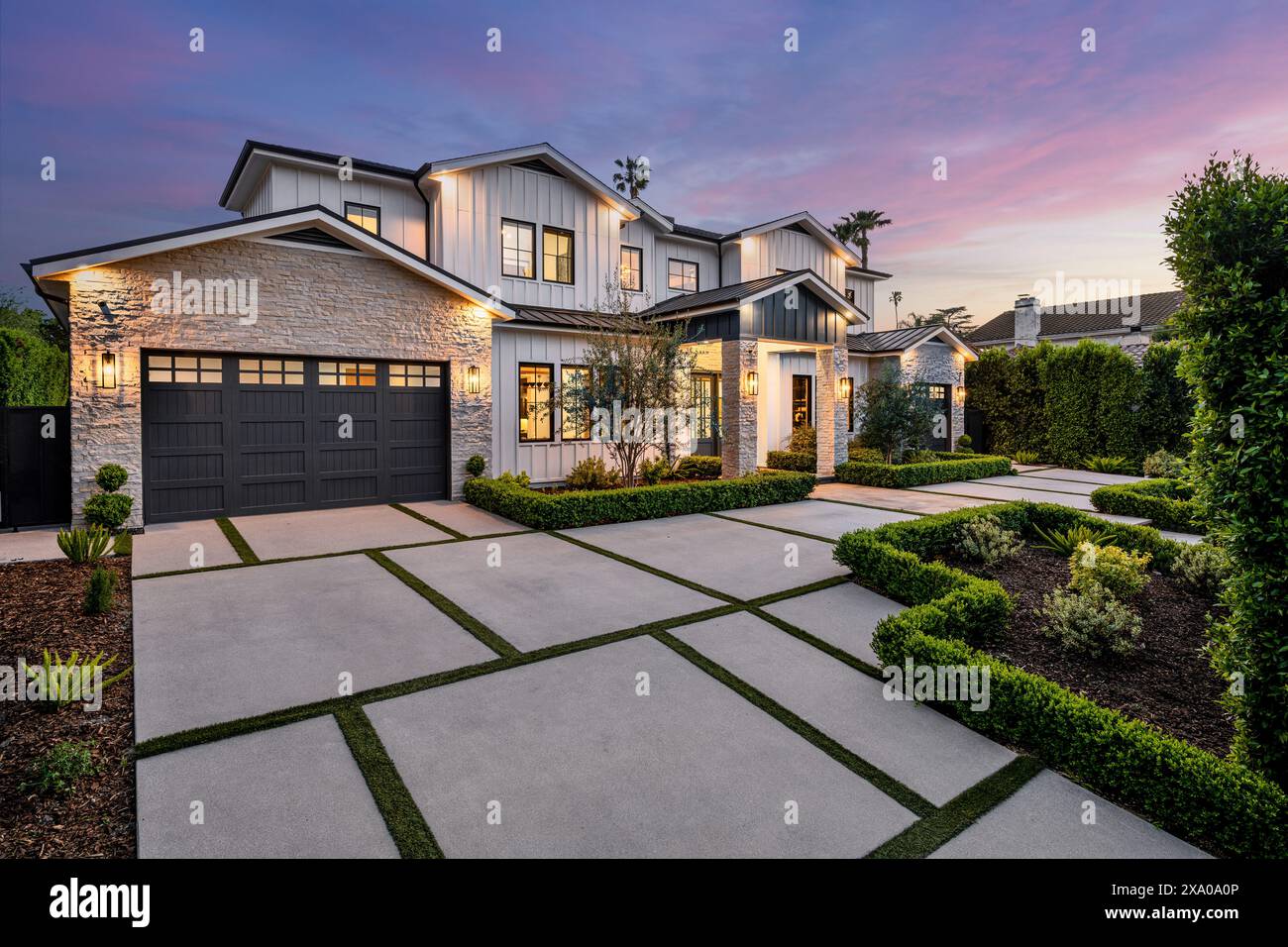 A pathway runs through an outdoor front yard area, flanked by two ...