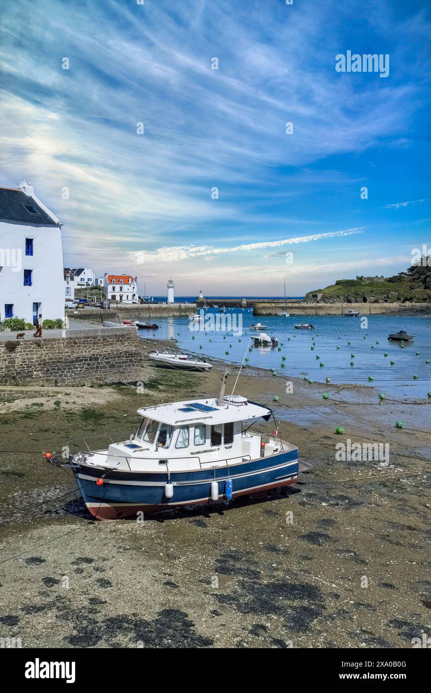 Sauzon in Brittany, the typical harbor with bots and lighthouse Stock ...