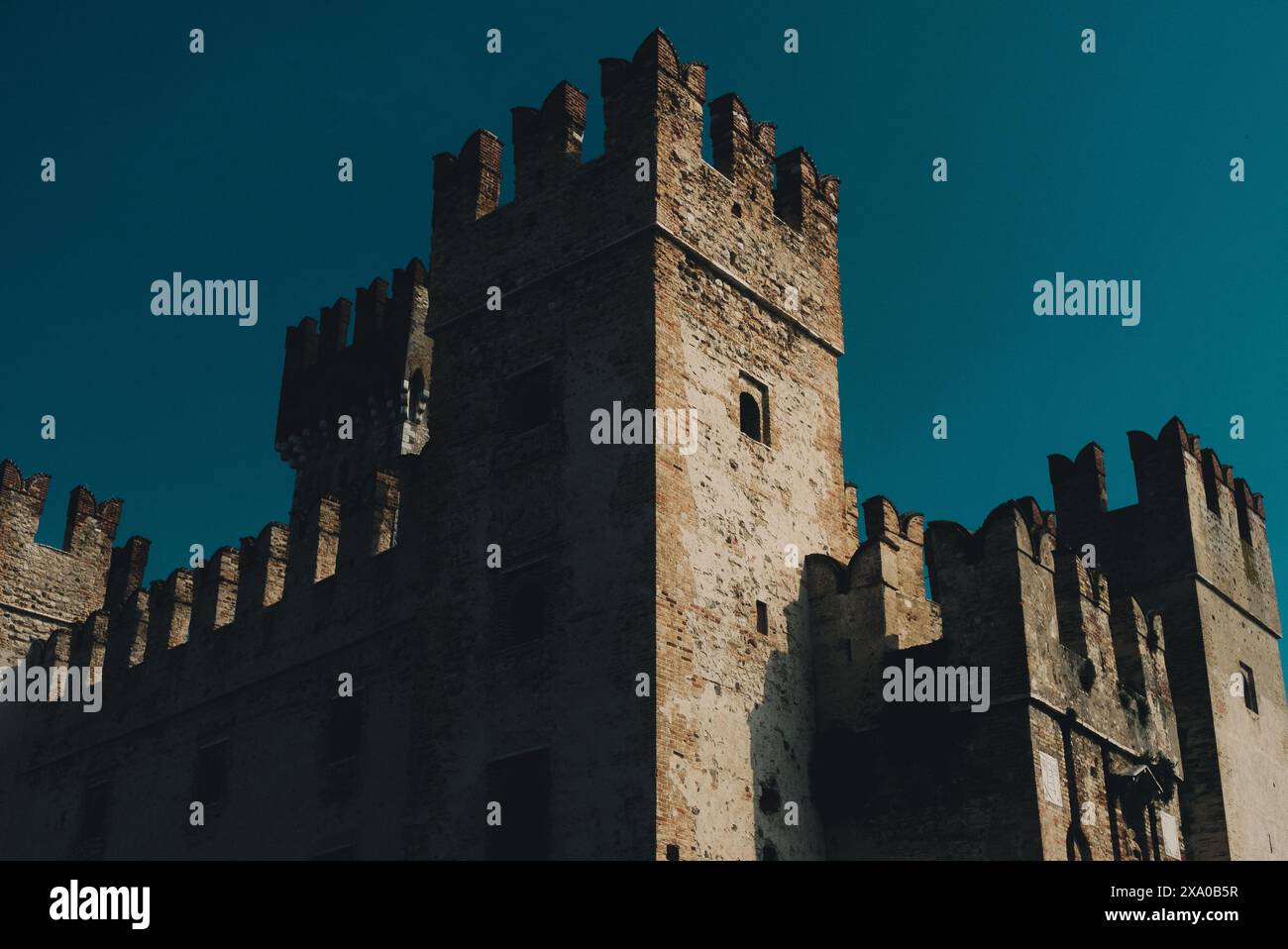 A scenic view of a medieval castle at Garda Lake in Sirmione, Italy ...