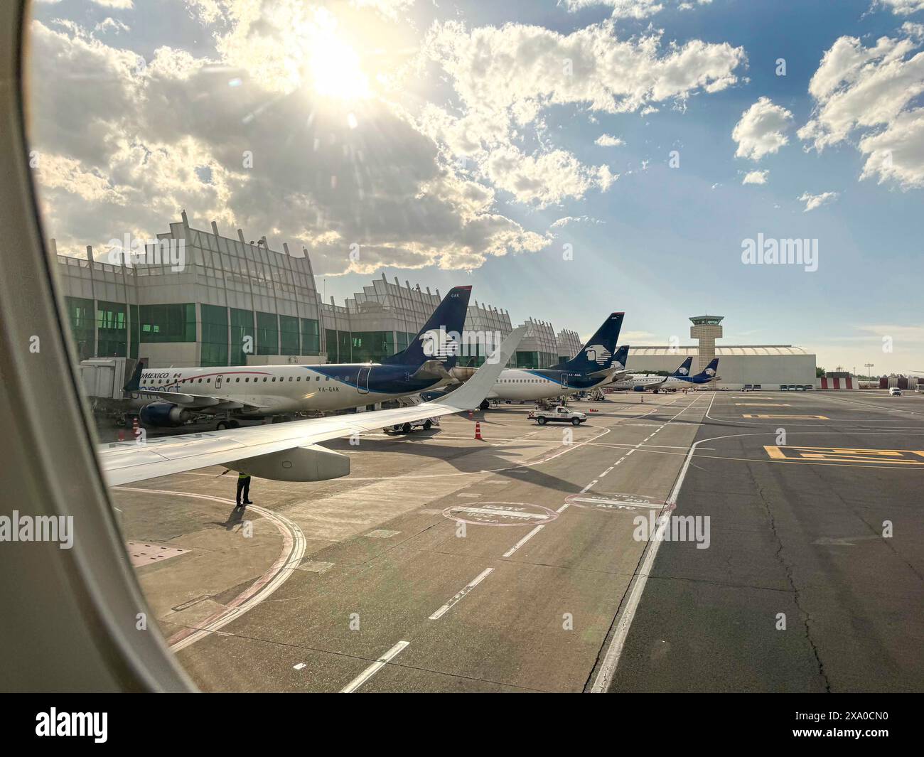 Window and wing of an Aero Mexico airplane arriving at terminal 2 or T2 ...