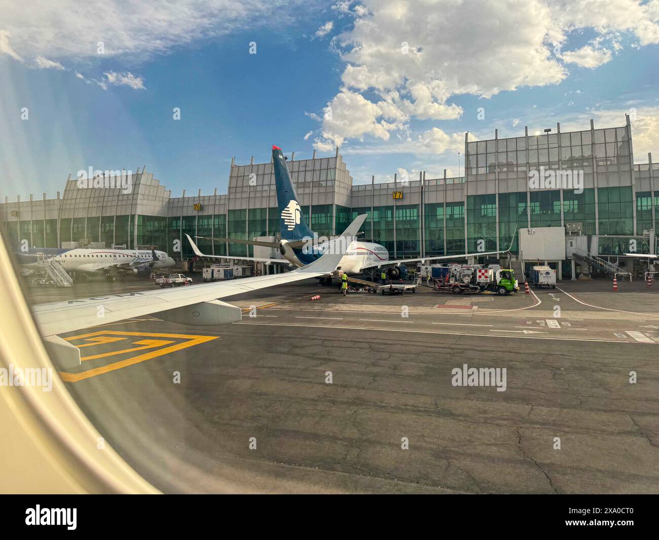 Window and wing of an Aero Mexico airplane arriving at terminal 2 or T2 ...