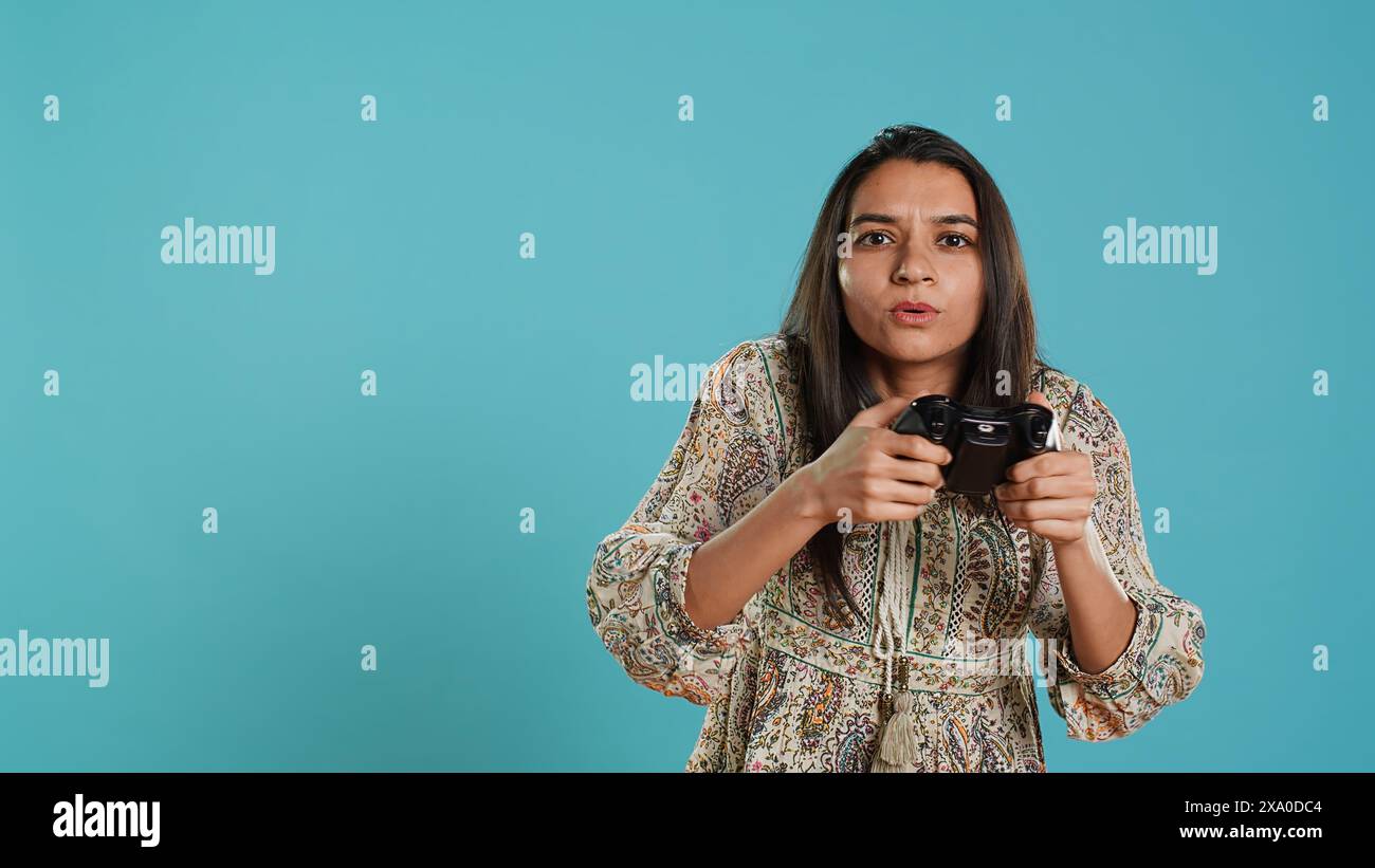 Upset woman showing thumbs down sign gesturing holding controller after ...