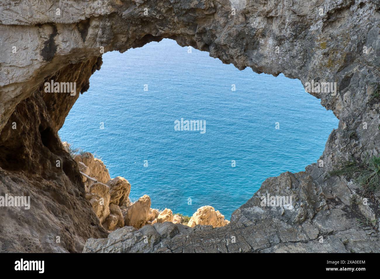 A Cave entrance in Italy on the Ocean Stock Photo - Alamy