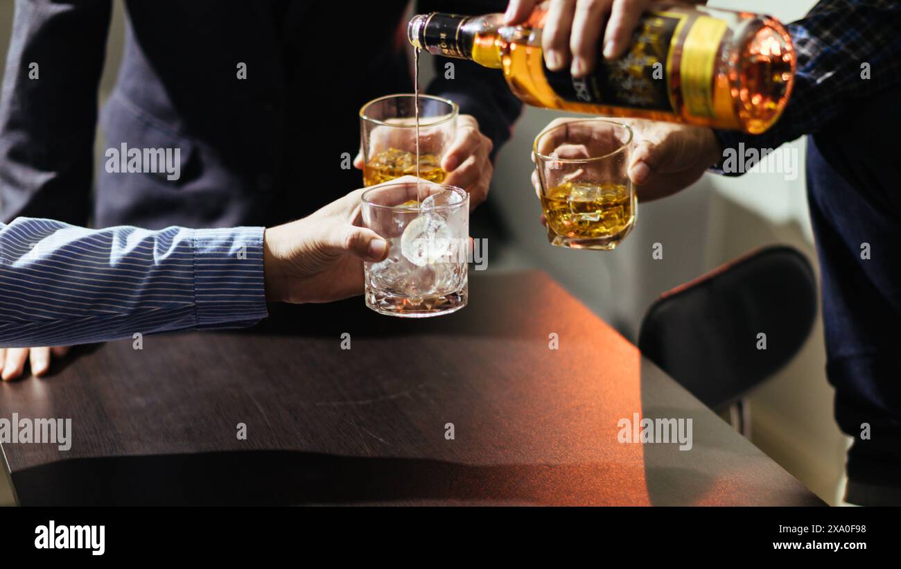 Businessmen and investors drink alcohol together in office after ...