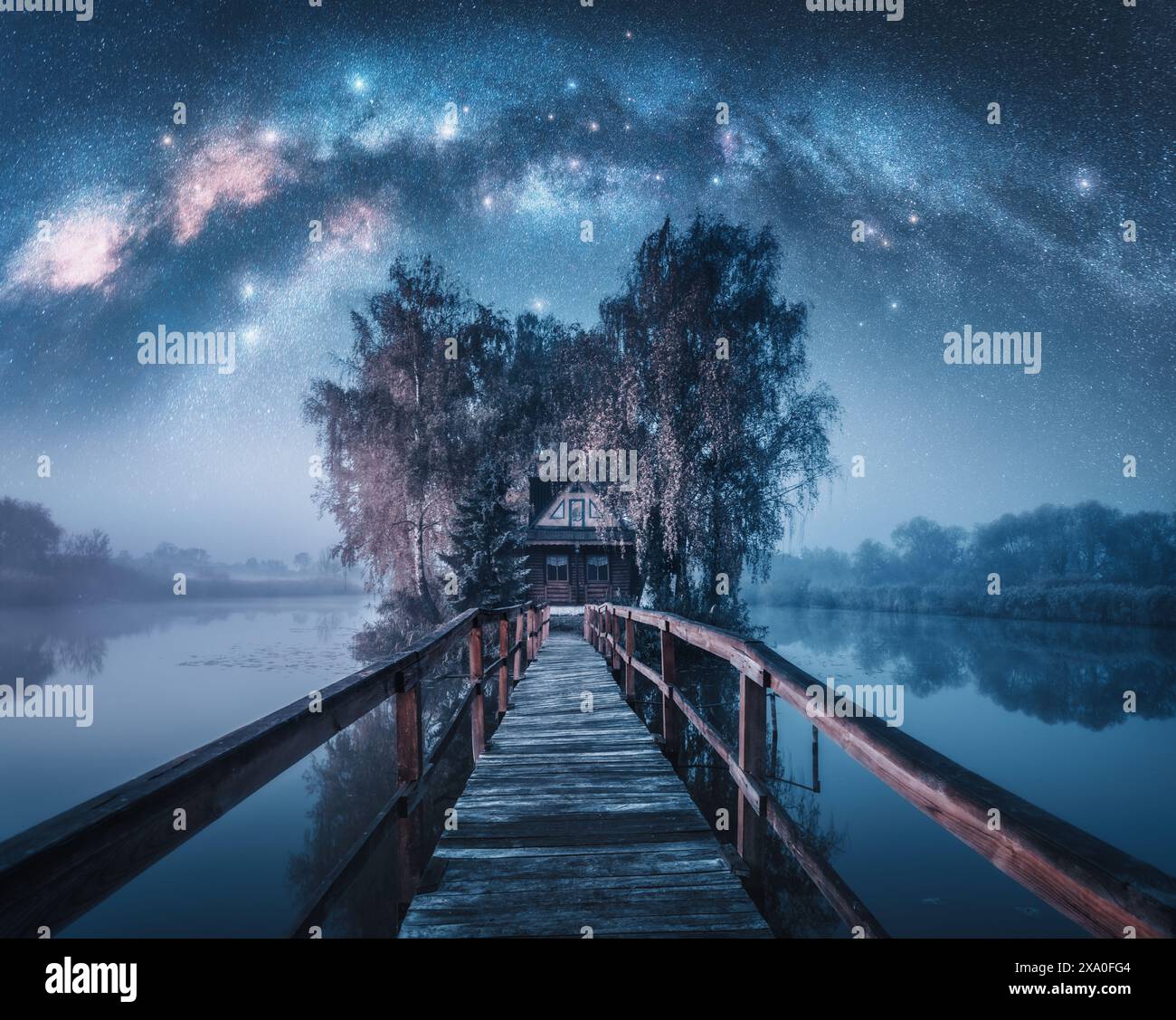 Wooden walkway and house surrounded by trees, Milky Way galaxy Stock ...