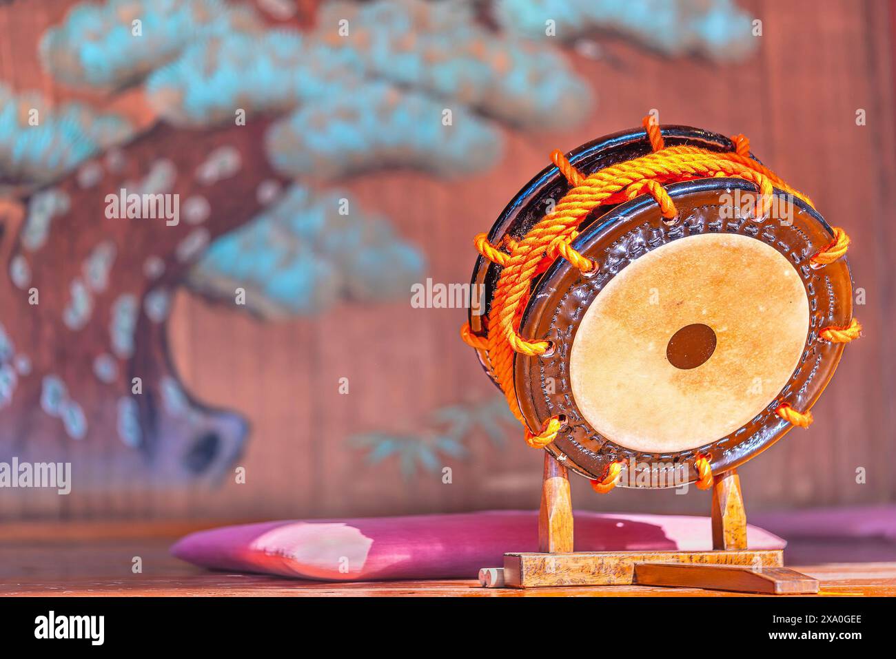 Japanese shime-daiko drum whose edges are laced with thick orange rope ...