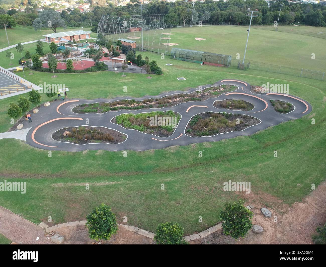 An aerial view of a race track with a football field in the background ...