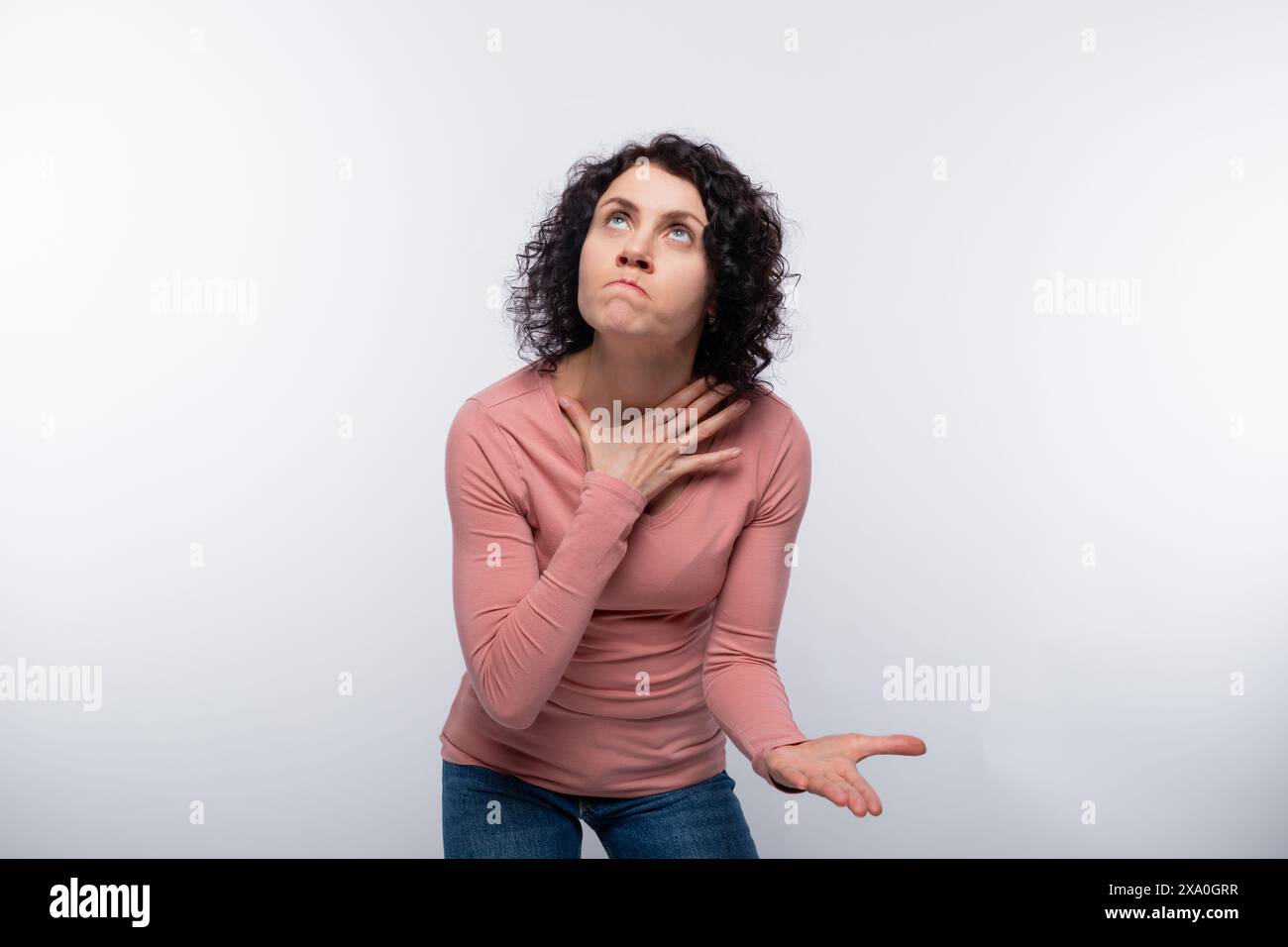 Confused angry european adult woman with curls on white background with ...