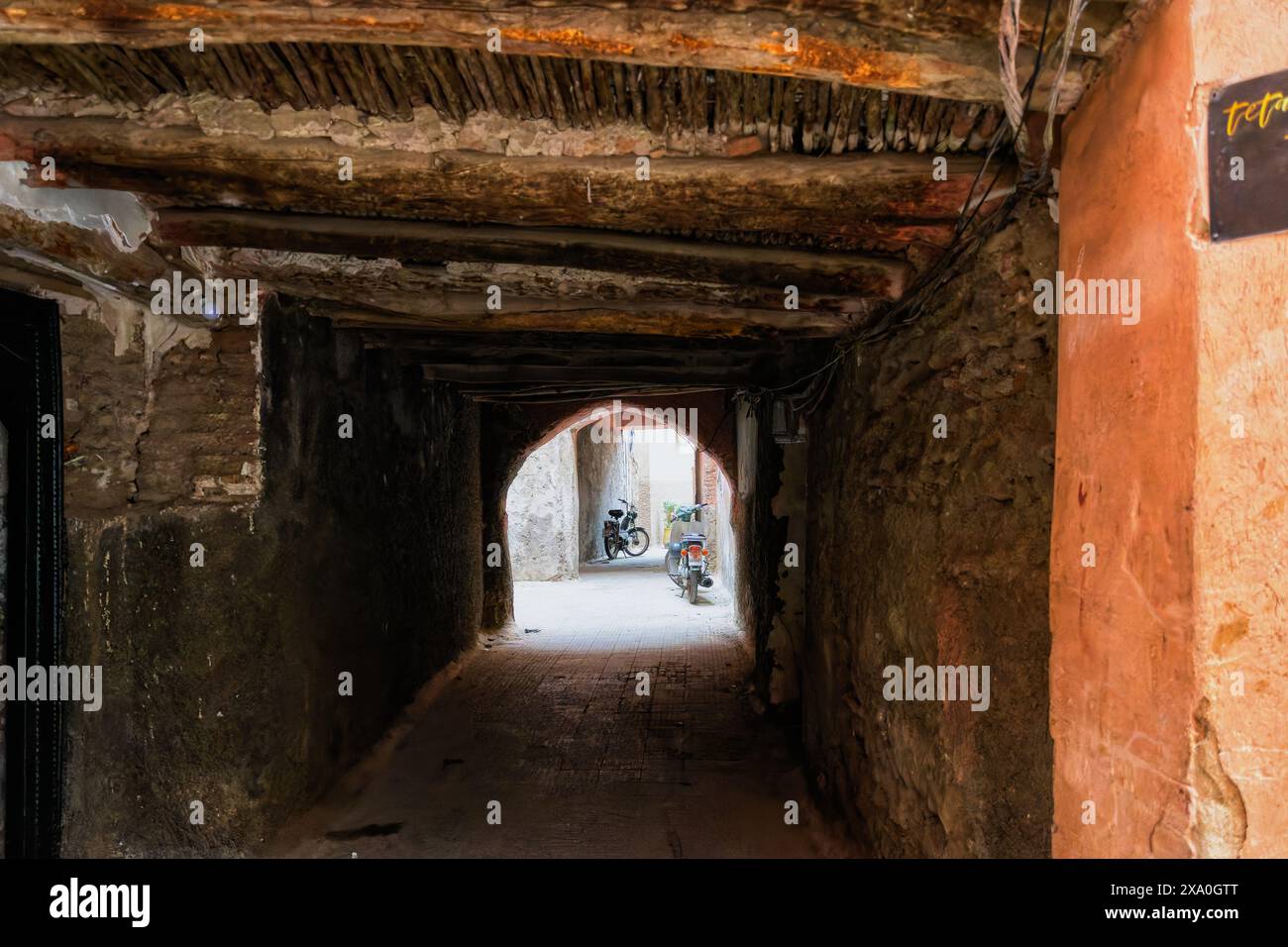 A typical passageway of the city of Marrakech in Morocco with brick and ...