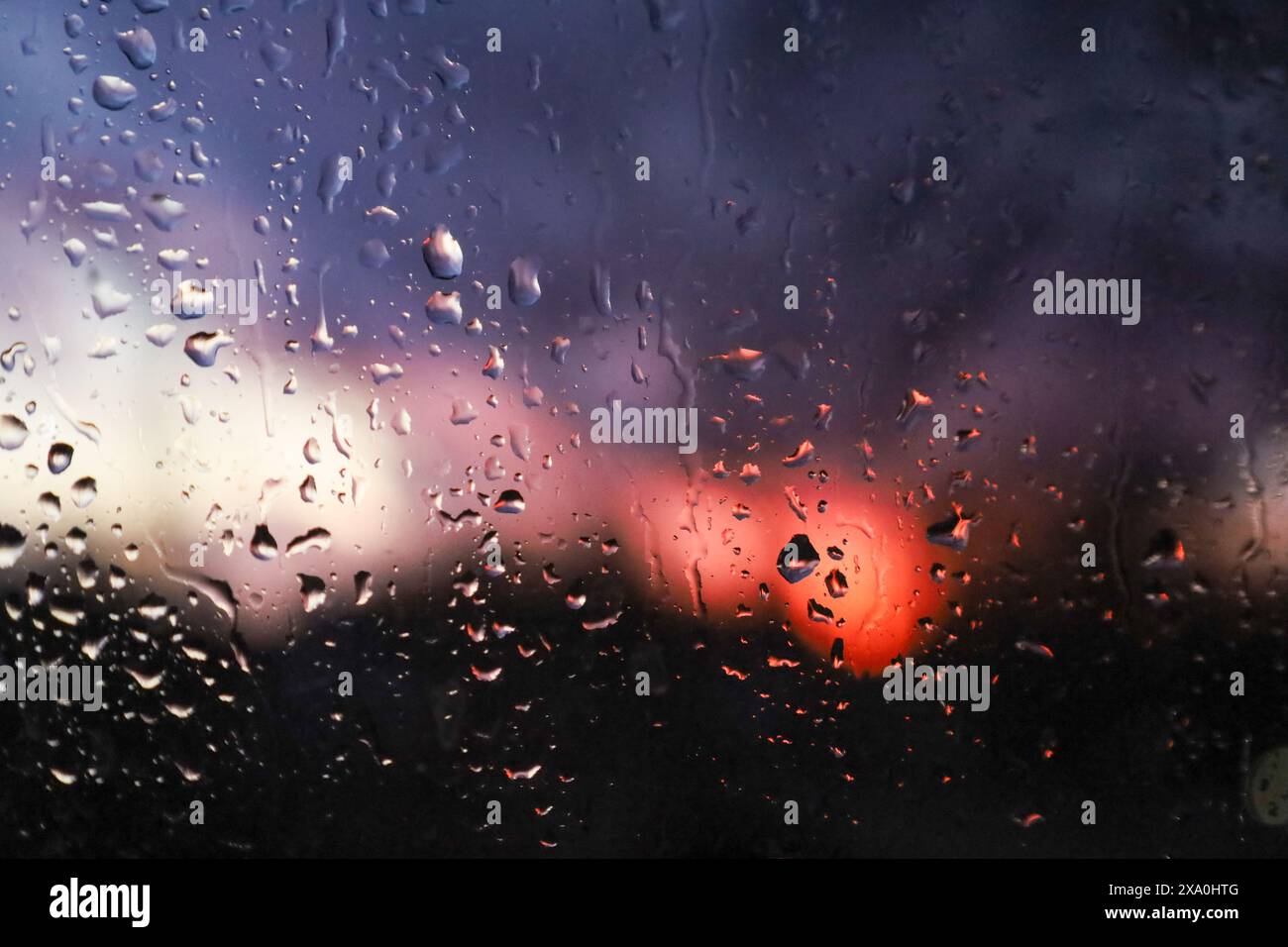 View through rain-streaked window at sunset Stock Photo - Alamy