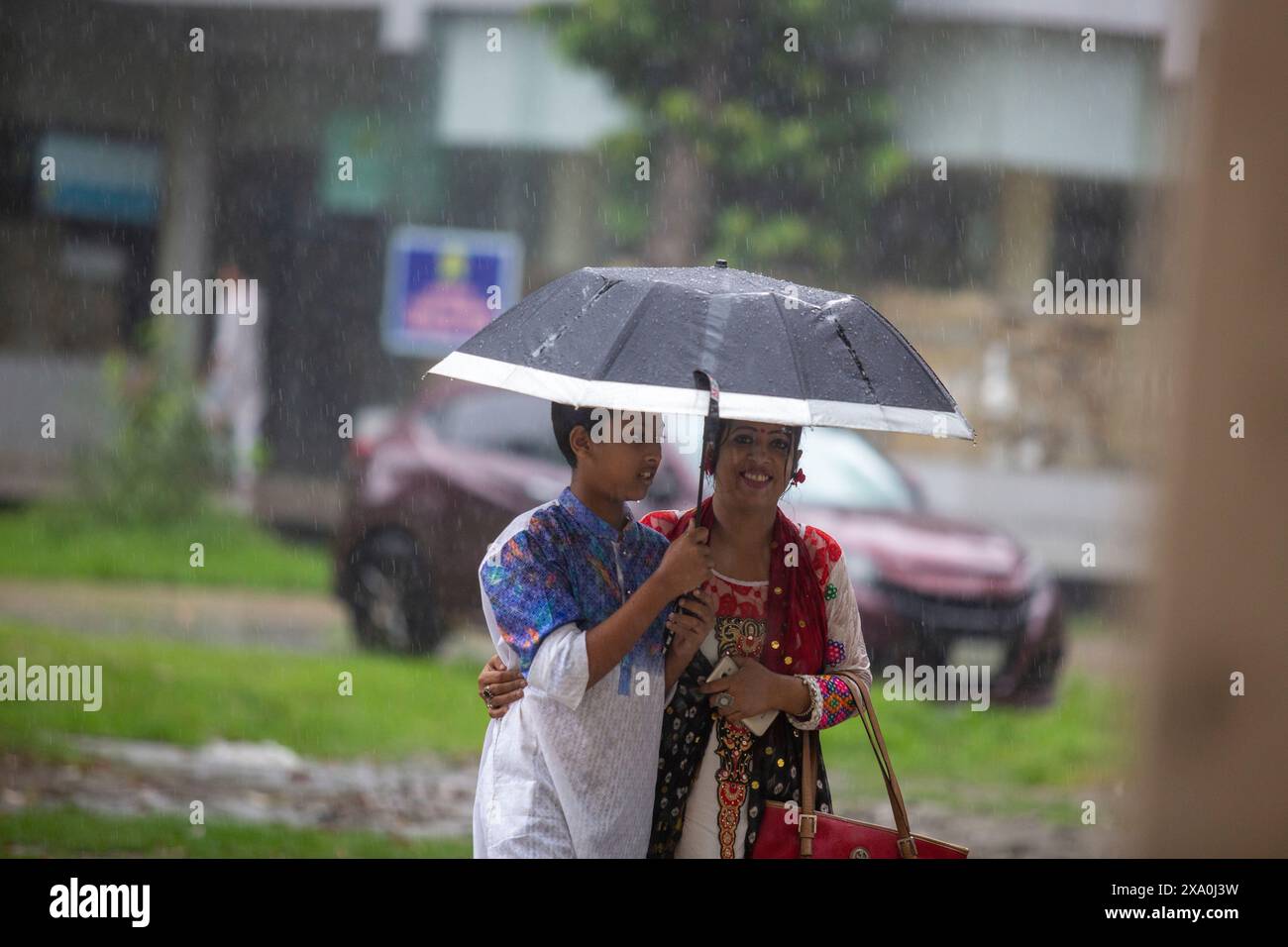 A mother and son enjoying rain in Dhaka, Bangladesh Stock Photo - Alamy