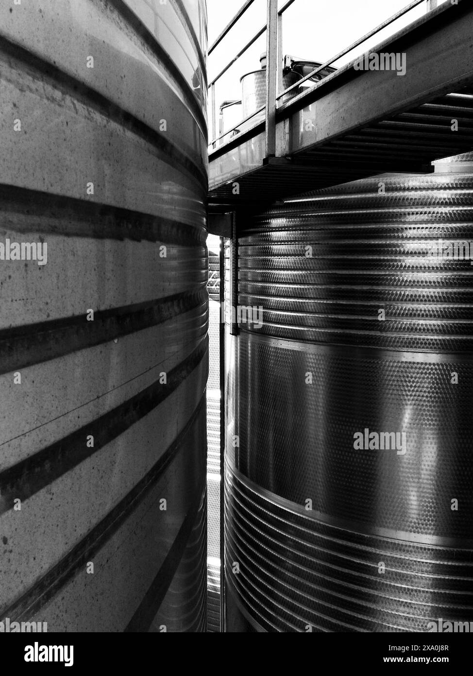 The row of various sized metal tanks in industrial setting Stock Photo ...