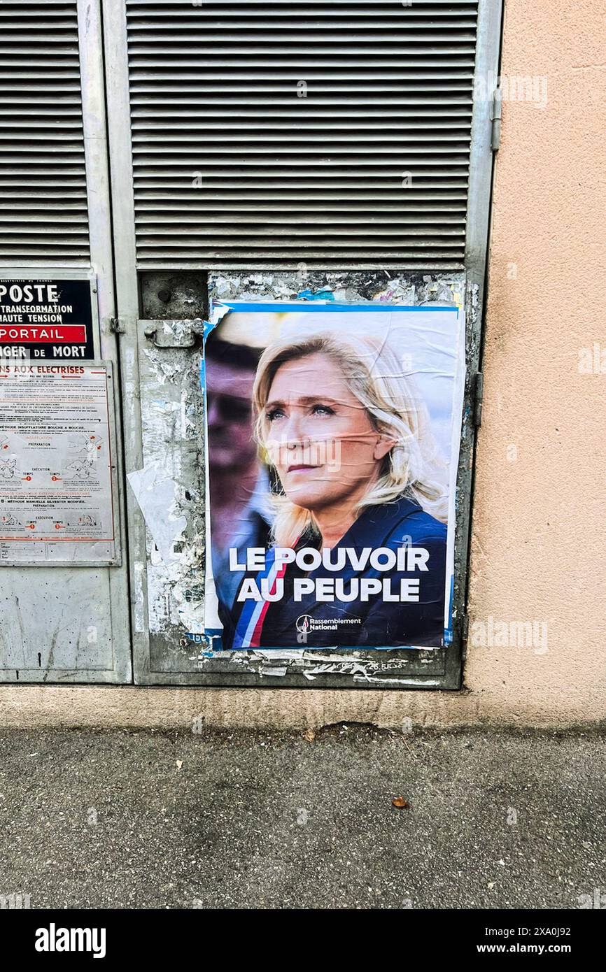A campaign poster for Marine Le Pen hangs on a building in ?Saint ...