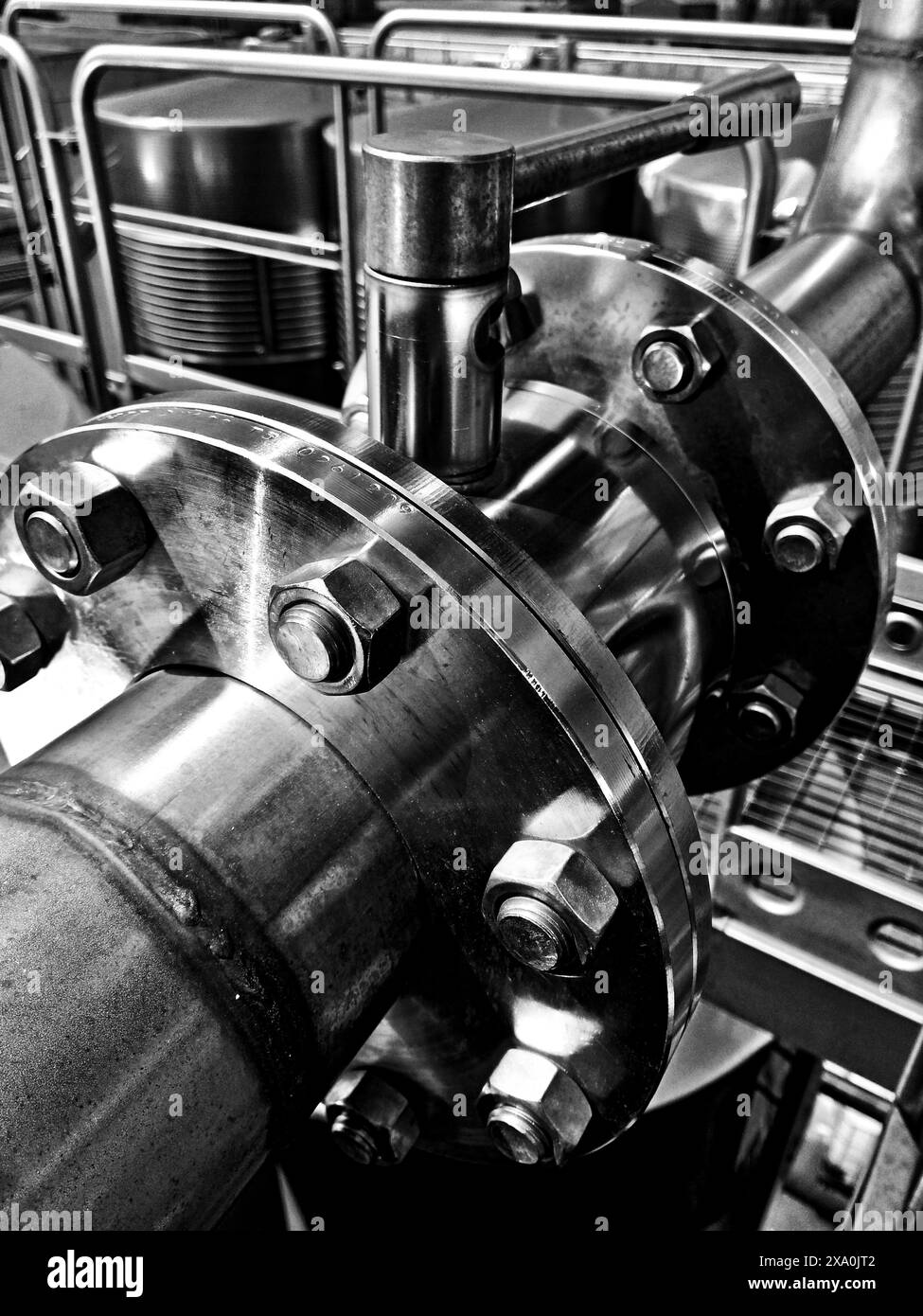 A monochrome photo of a complex machine with numerous pipes Stock Photo ...