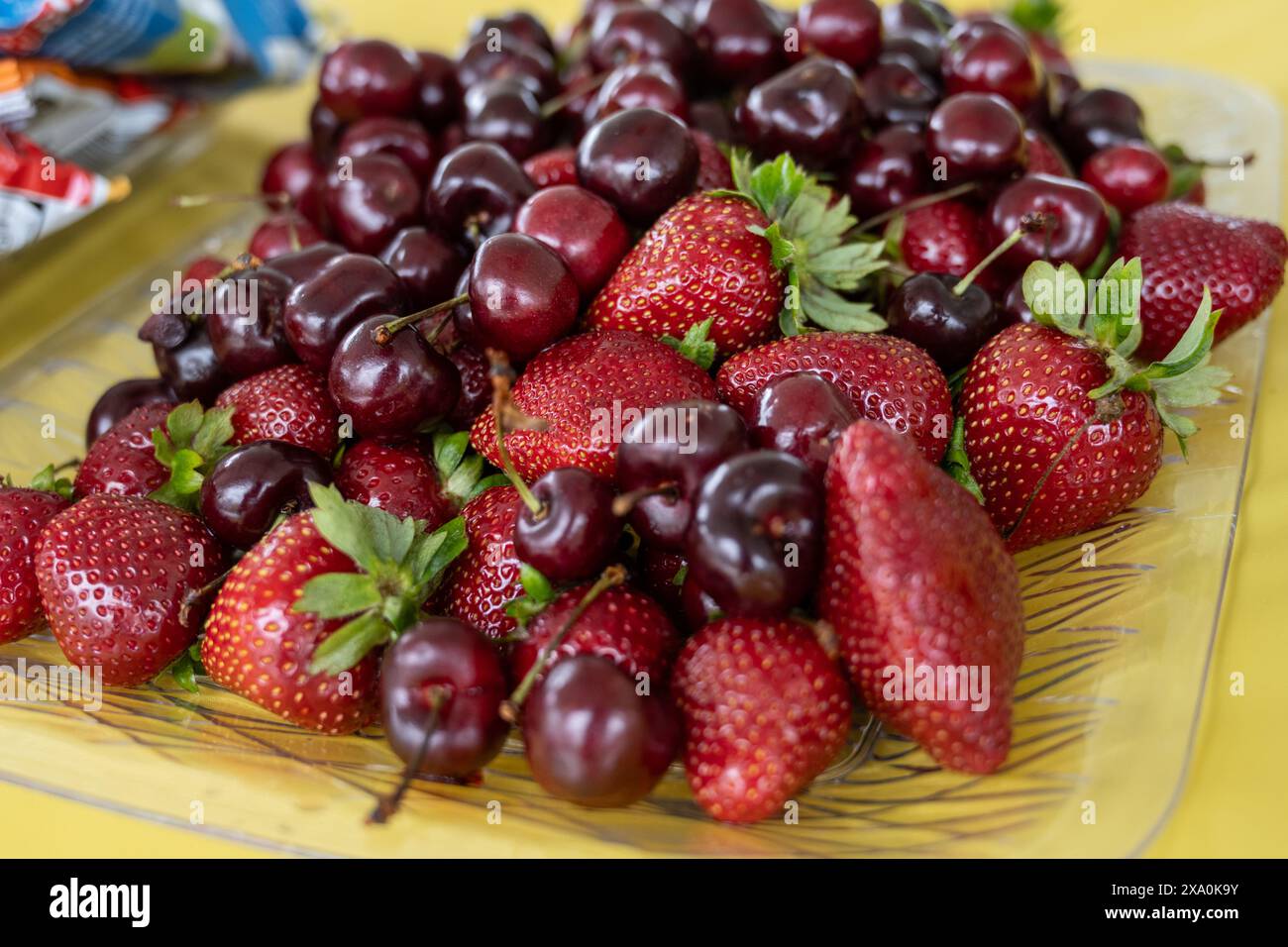 Plate of strawberries and cherries are washed and ready to be eated by ...