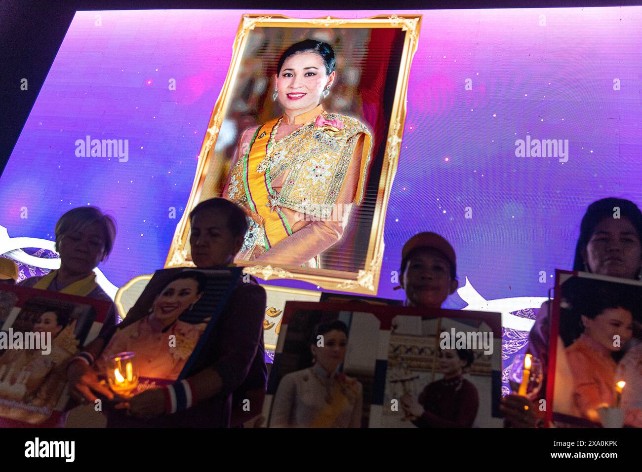 Thai royalist supporters hold the portraits of Thai Queen Suthida and ...