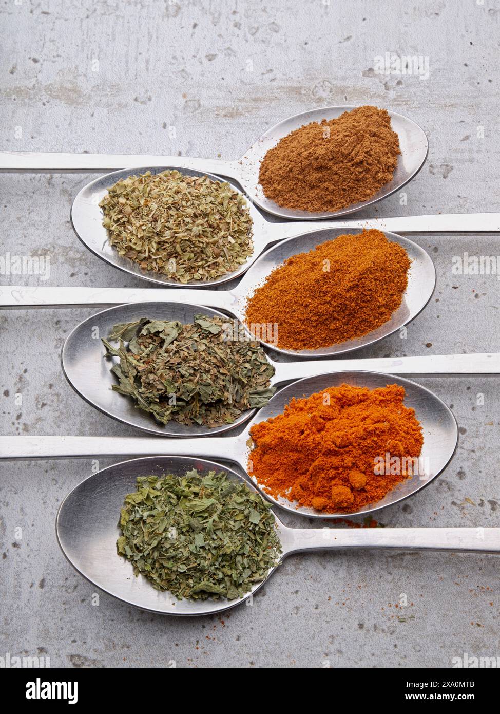 A flat lay photo of various dried herbs and spices such as cayenne ...