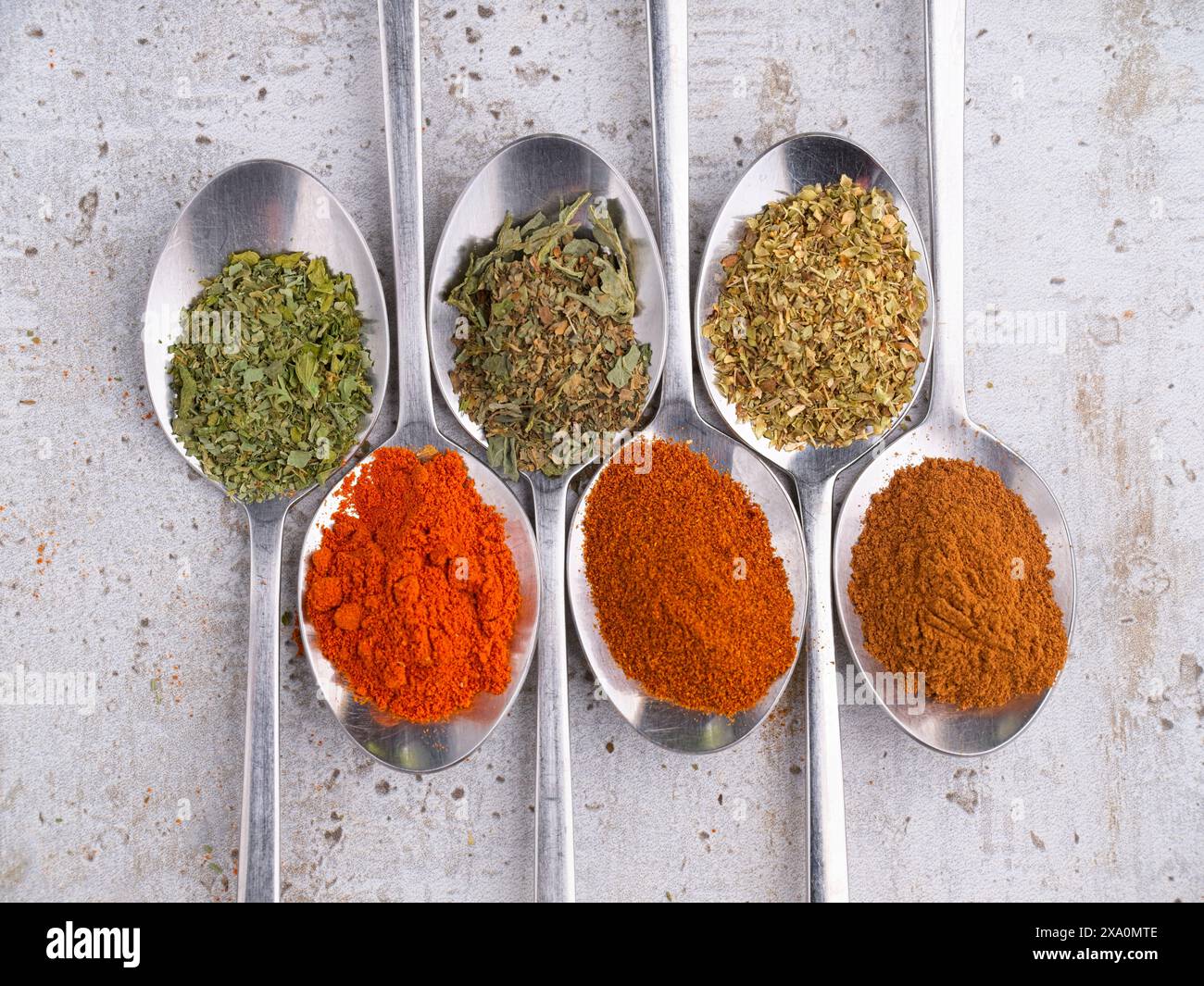 A flat lay photo of various dried herbs and spices such as cayenne ...