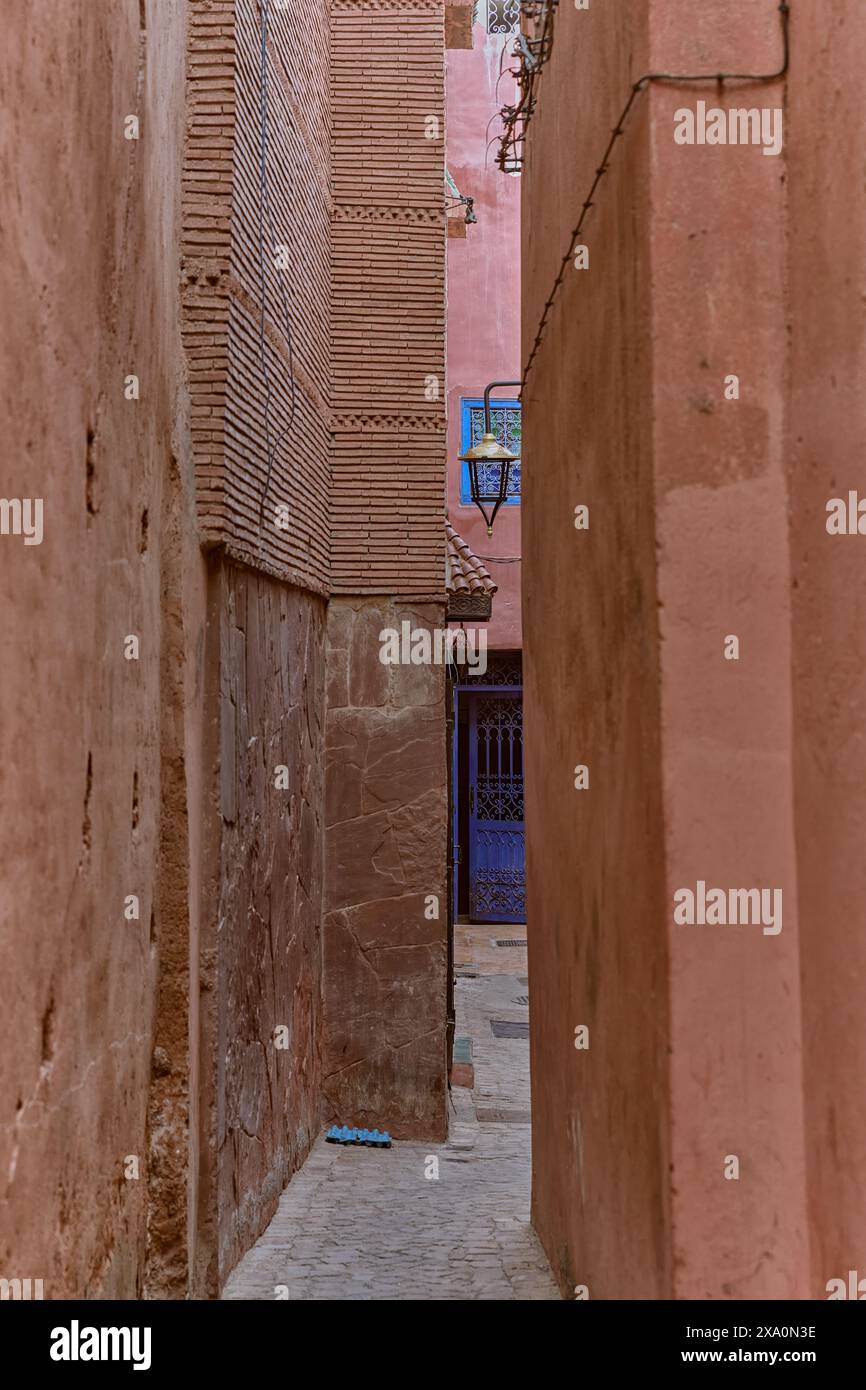 A narrow street of Marrakech in Morocco with its bronze street lamp and ...