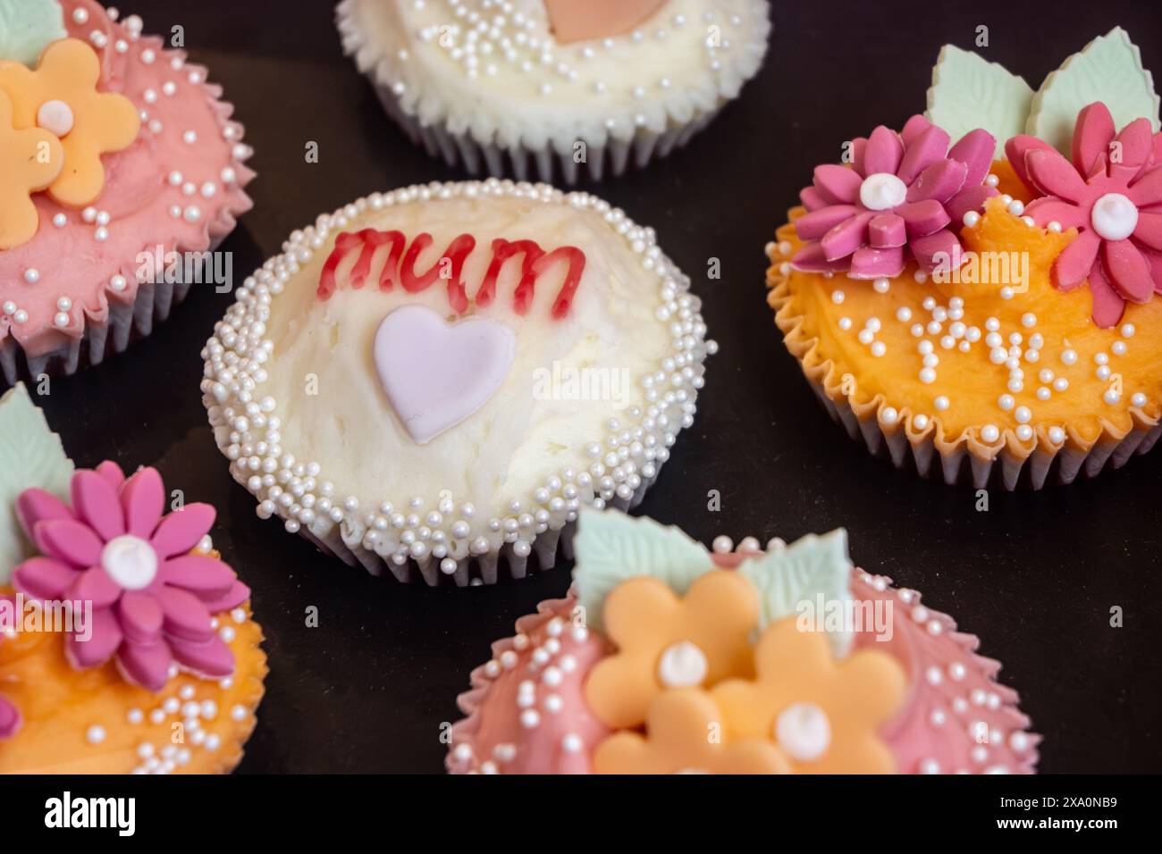 Colorful marzipan almongs cakes with decorative marzipan flowers on ...