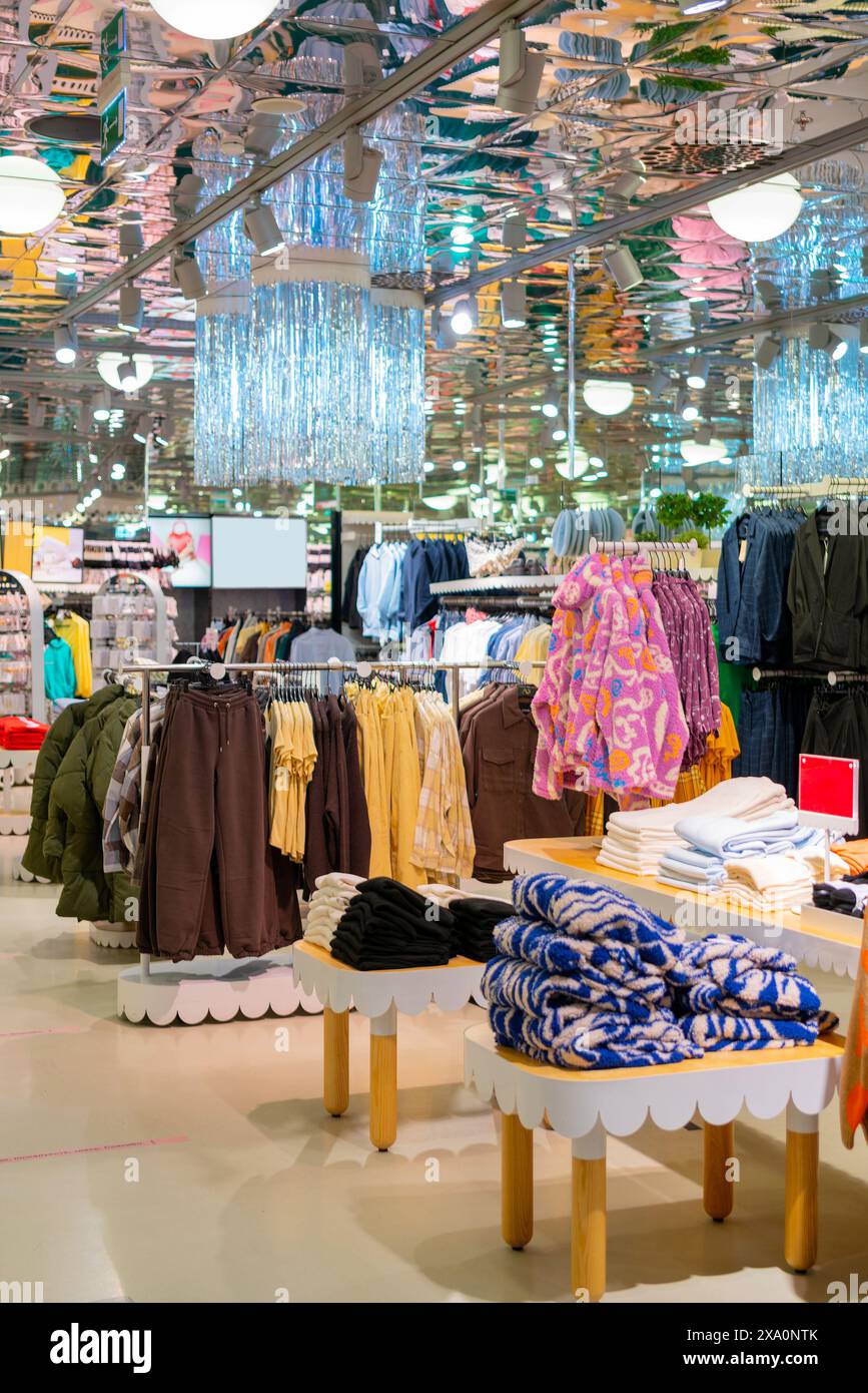A clothing store with colorful garments hanging from the hangers Stock ...