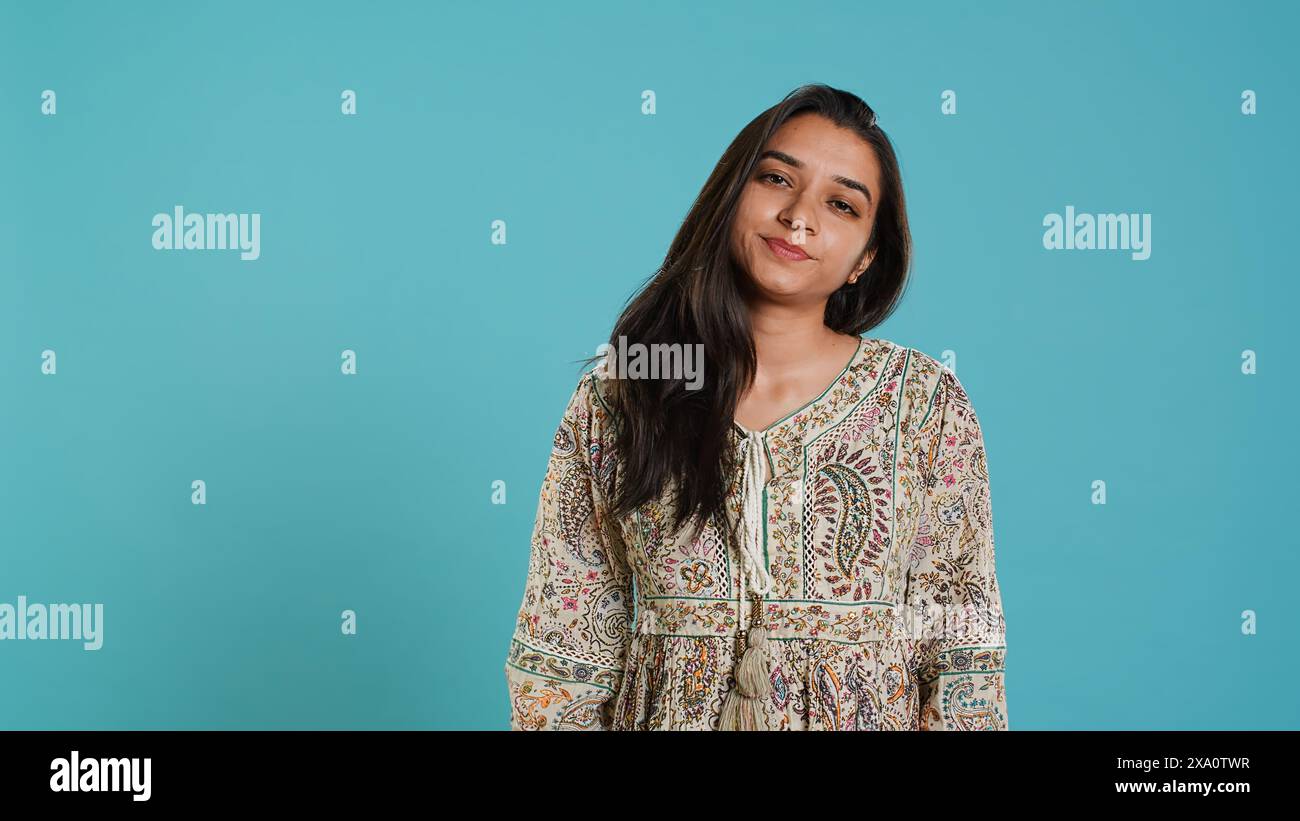 Portrait of cheerful friendly indian woman smiling, flipping long ...