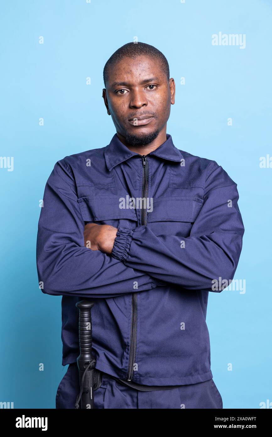 Portrait of serious proud security guard posing in uniform on camera ...