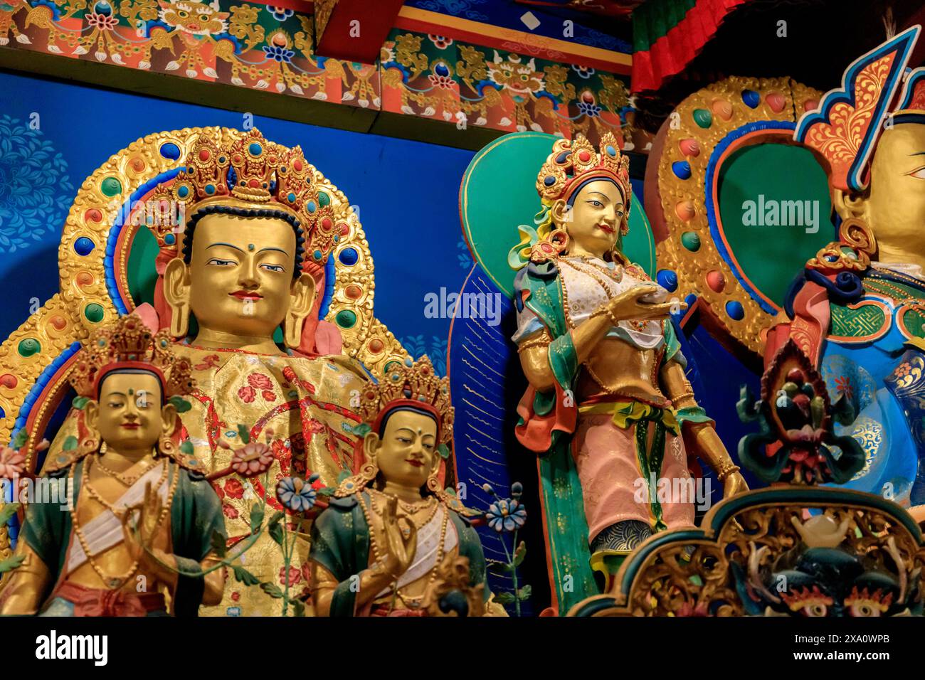 Buddhist temple interior featuring ornate decorations, statues of ...
