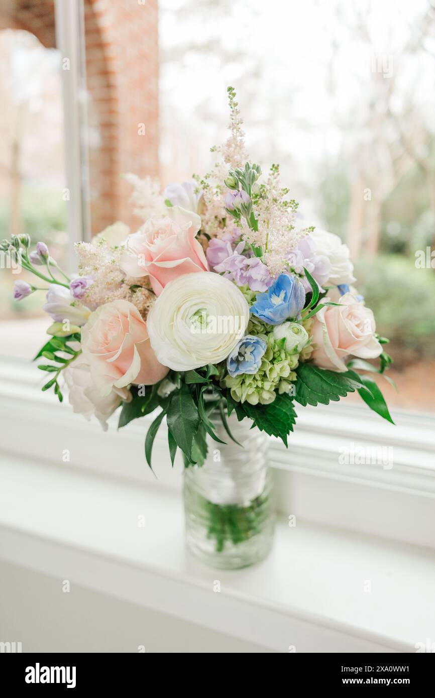 A lovely wedding reception bouquet on a window sill Stock Photo - Alamy