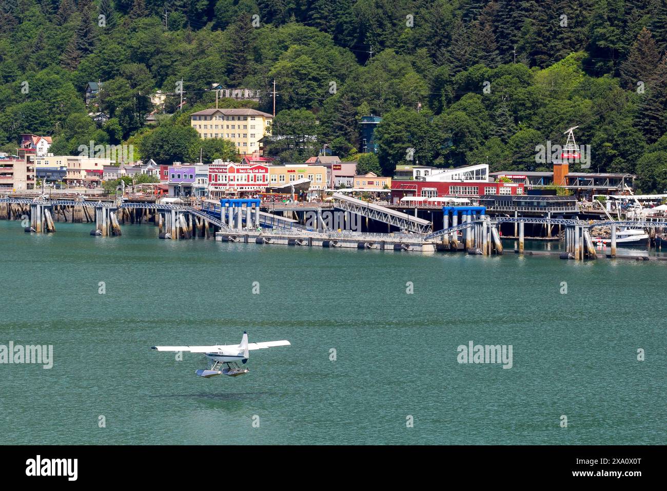 A seaplane floating over water near the town of Juneau, Alaska Stock ...
