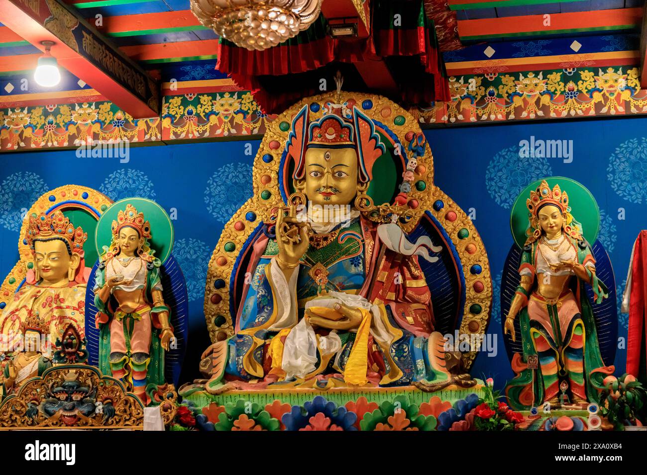 Buddhist temple interior featuring ornate decorations, statues of ...